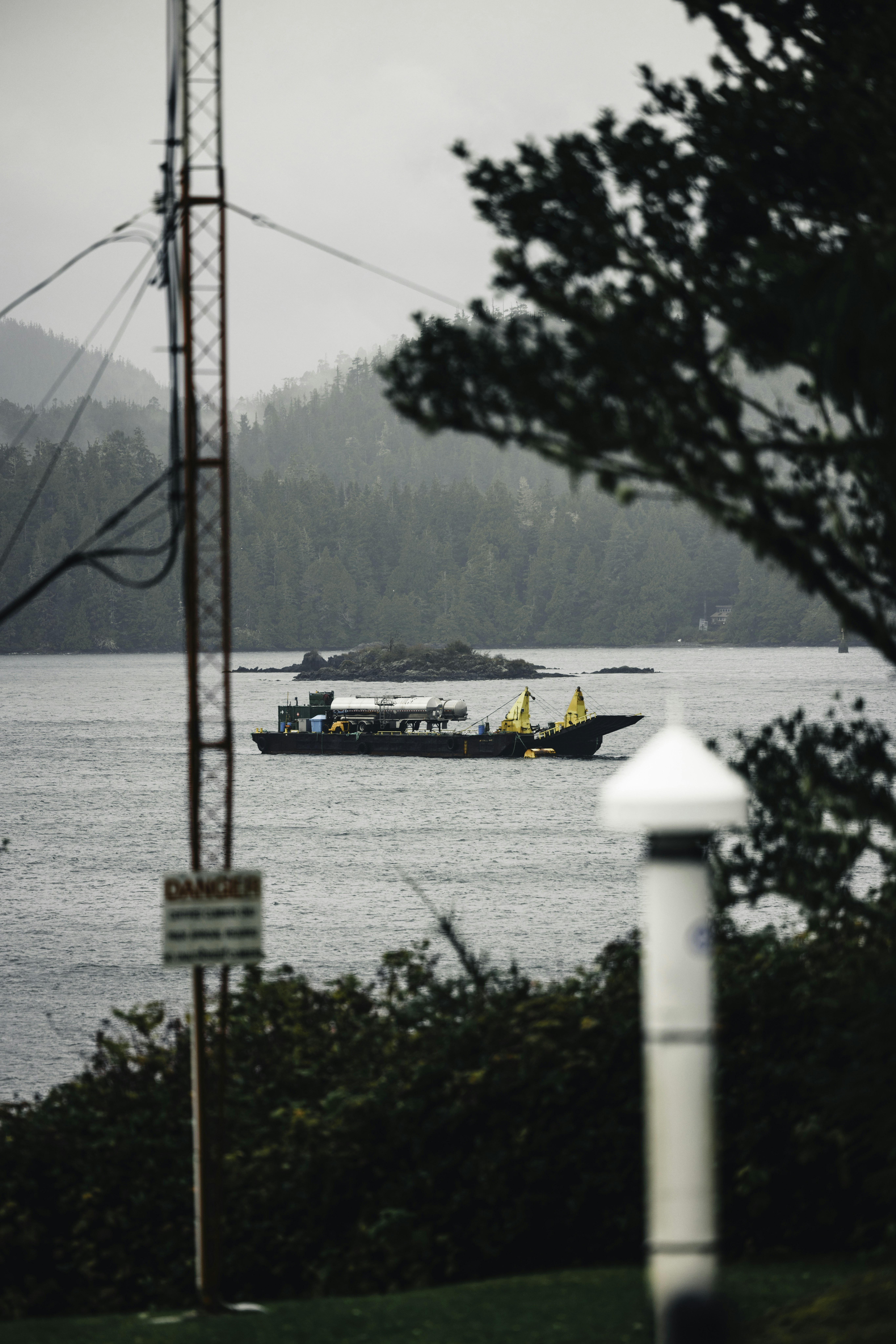 Boat on Misty Lake Beyond a Framing Foreground