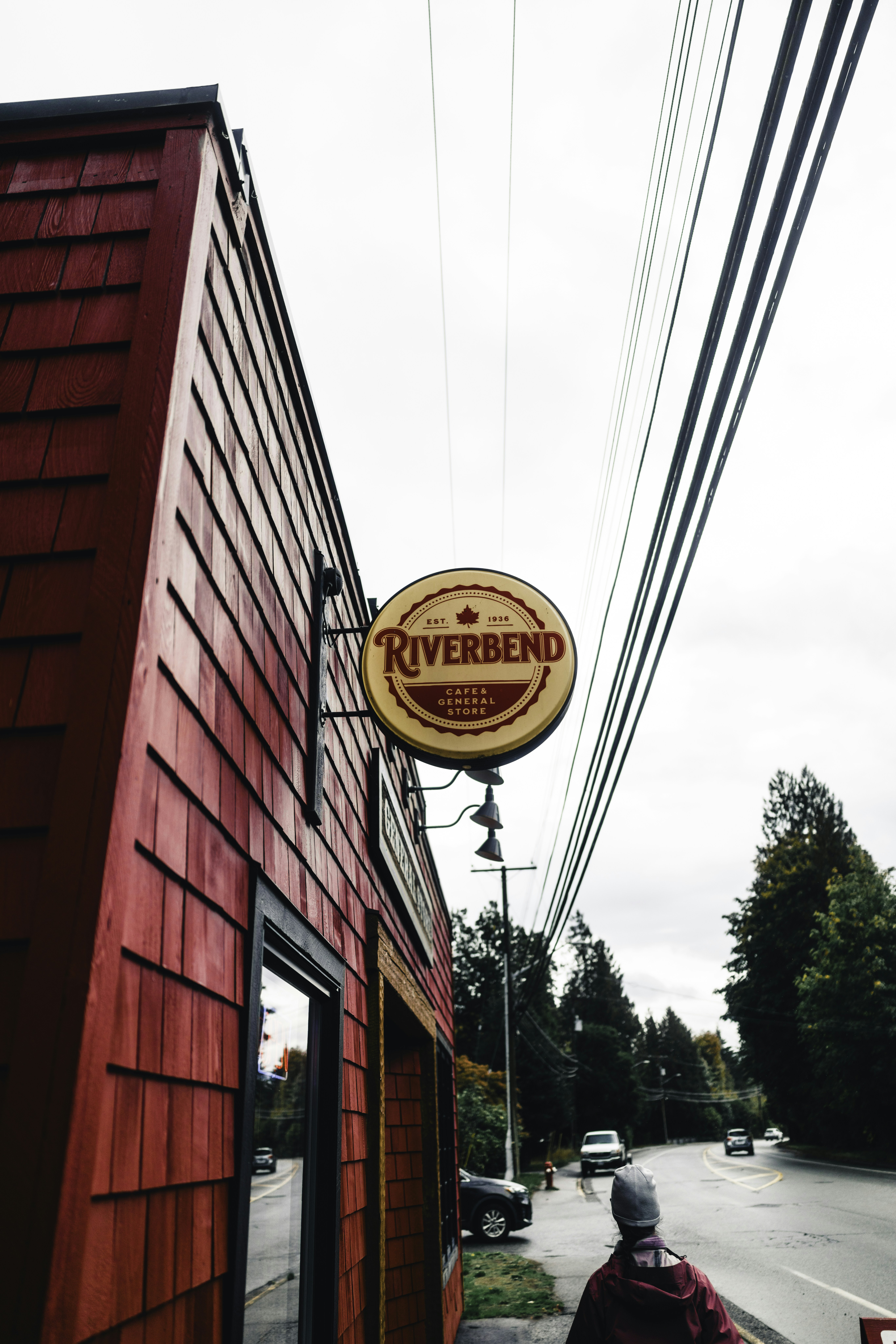 Red Riverbend Café Sign Over a Rainy Street