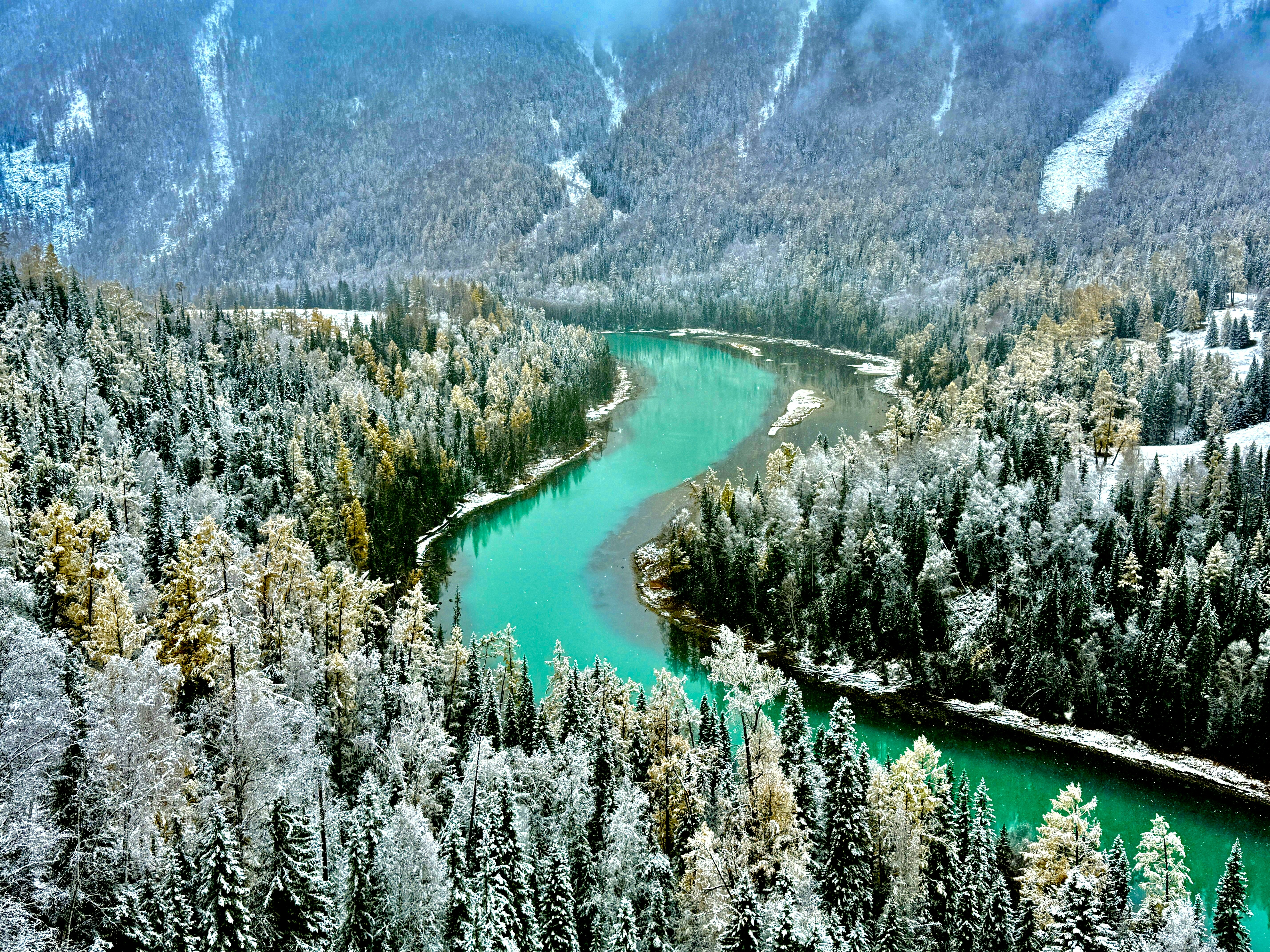 Emerald River Winding Through Snow-kissed Pines