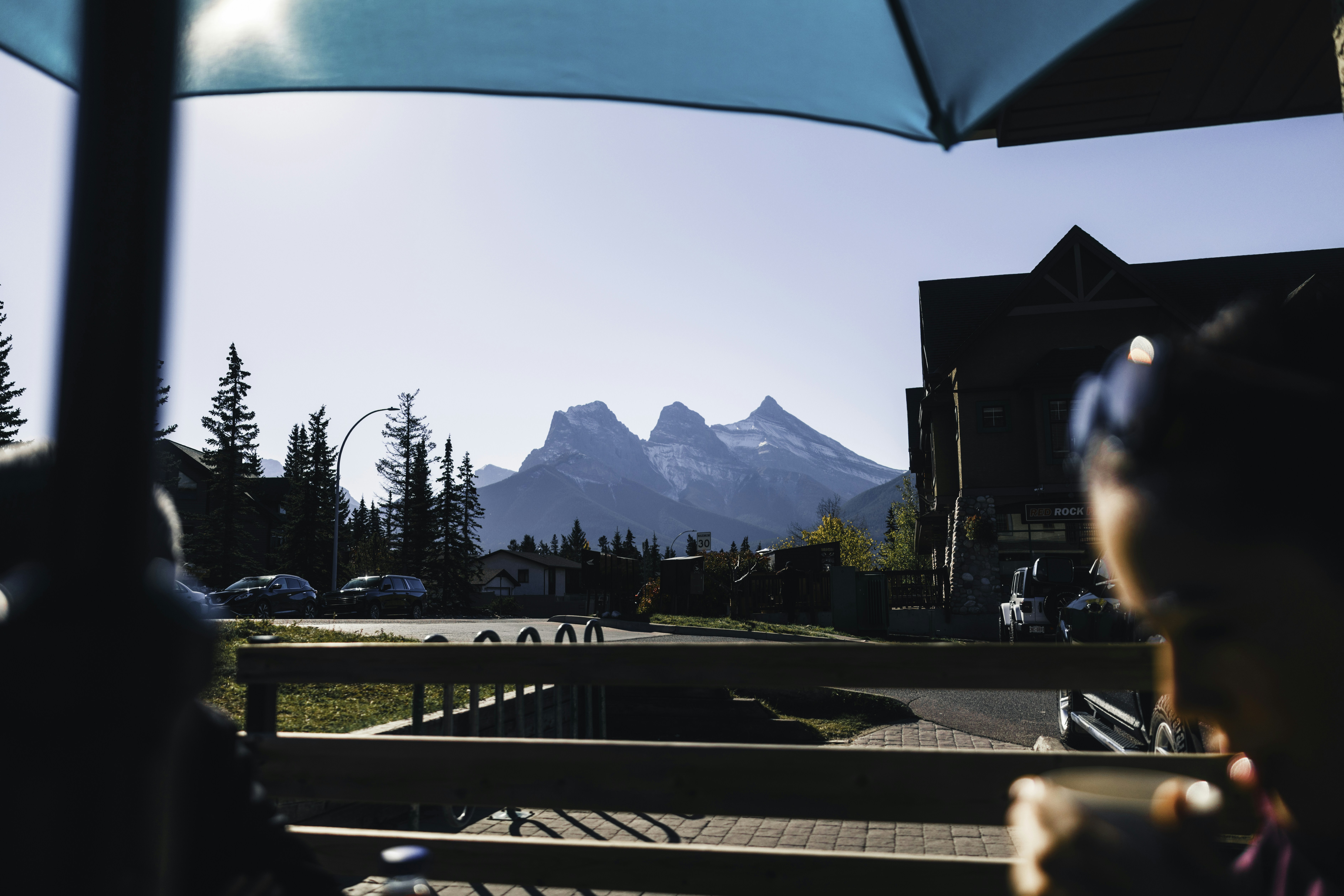 Sunlit Alpine Café Terrace Framed by an Umbrella