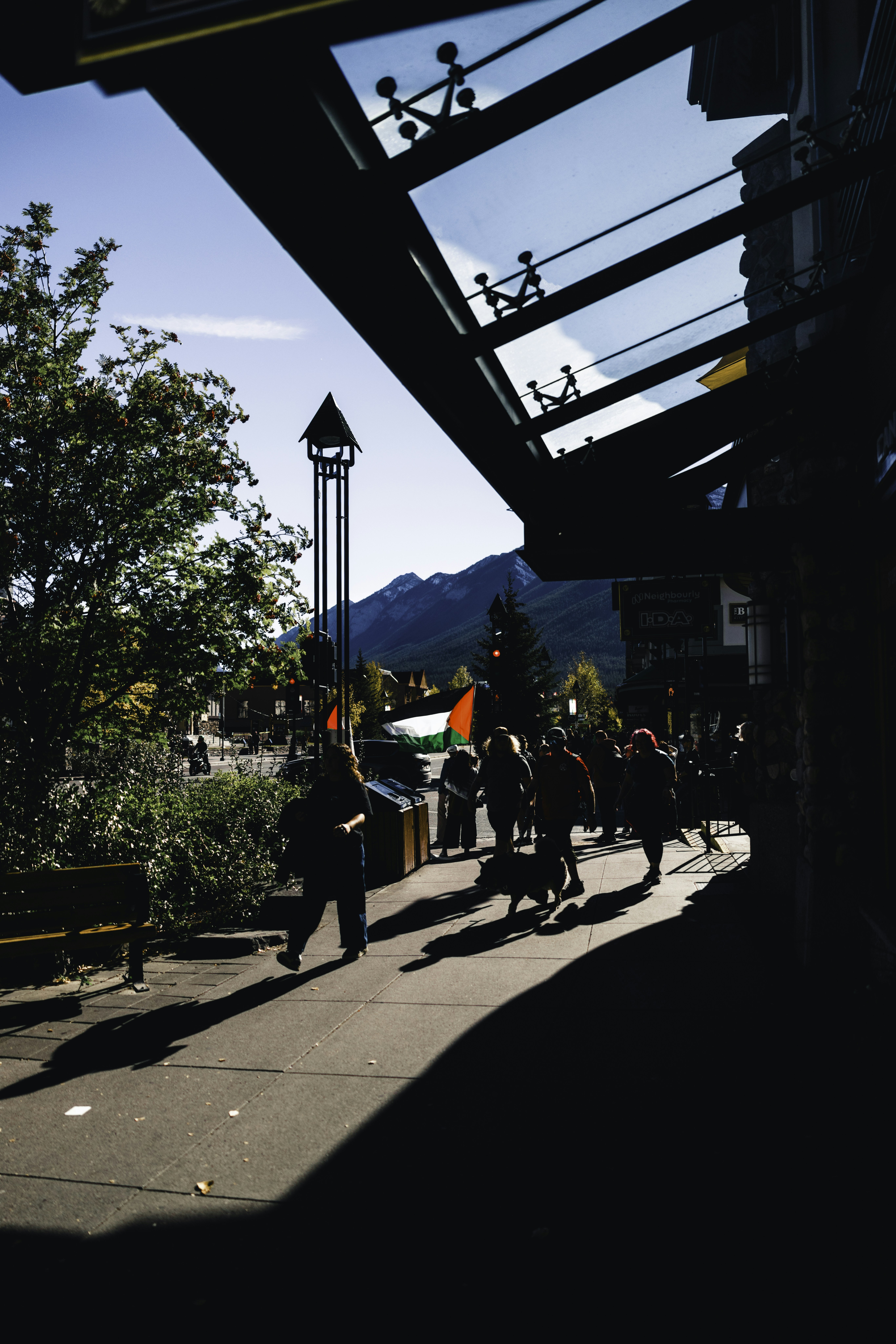 Mountain Town in Shade: Striding toward the Flag and the Light