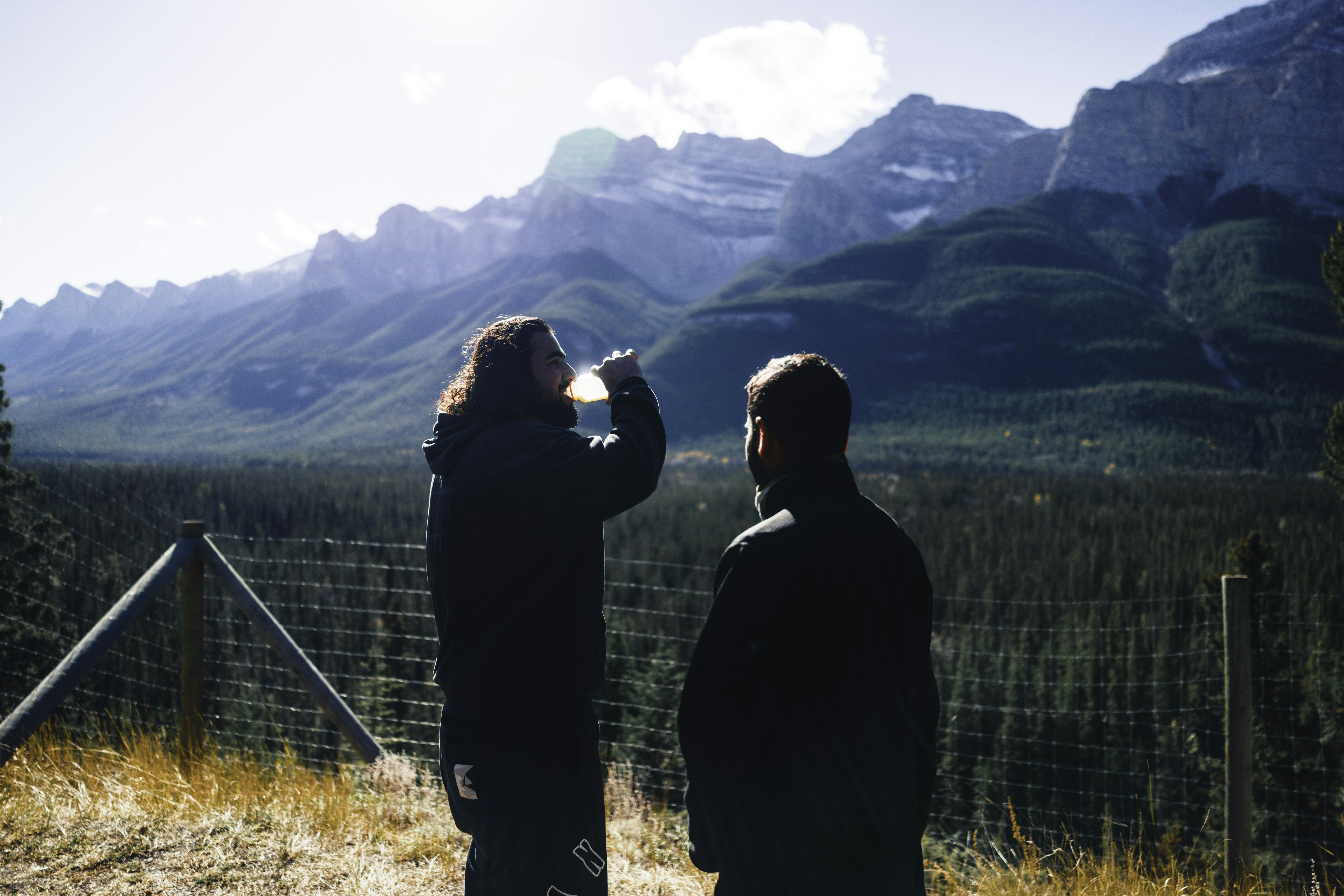 Gazing Toward the Grand: Two Friends Amid Mountain Echoes
