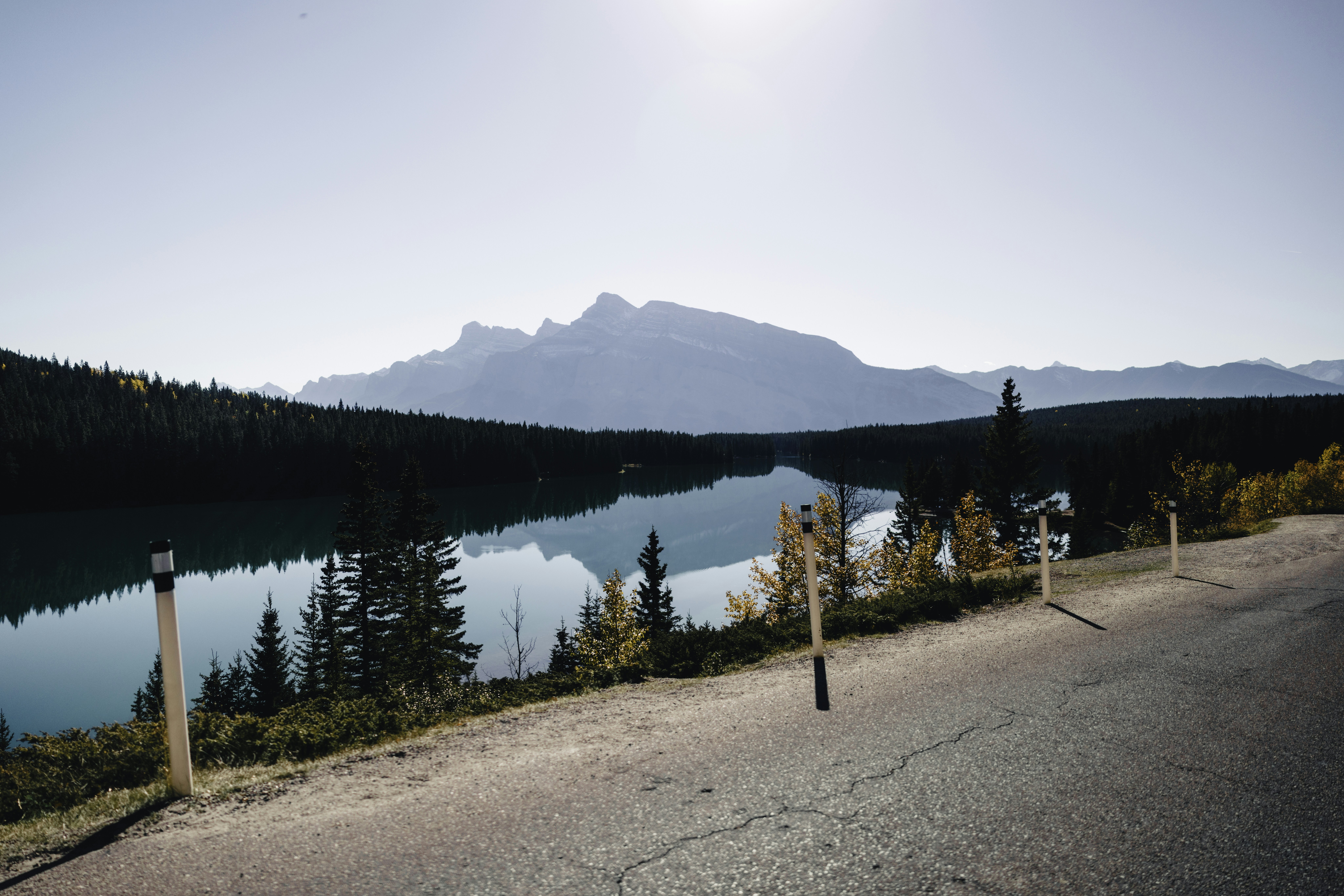 A Quiet Lake Road Beneath Snow-Capped Peaks