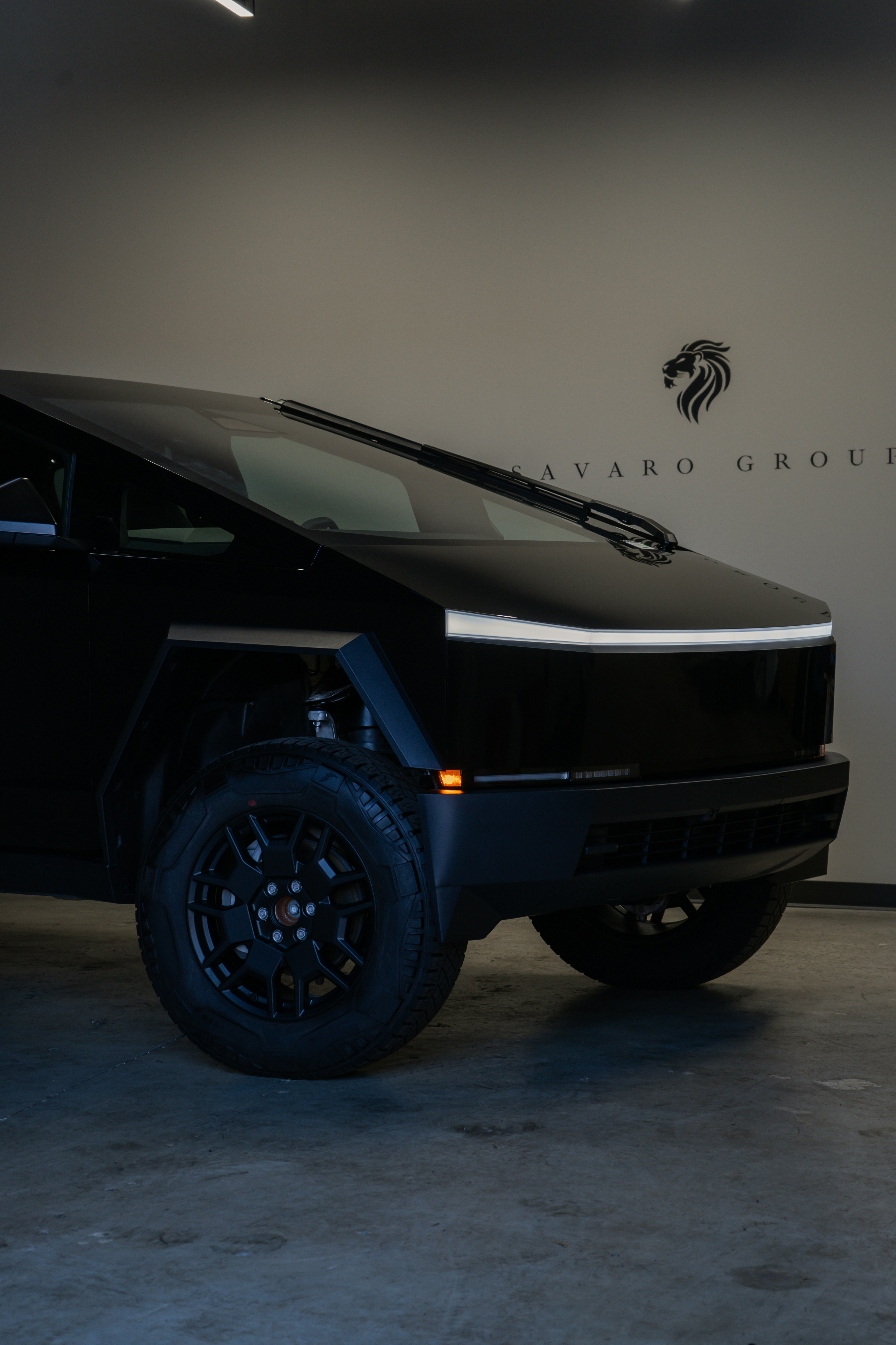 Midnight Power: A Sleek Black Utility Vehicle in an Atelier-like Gallery