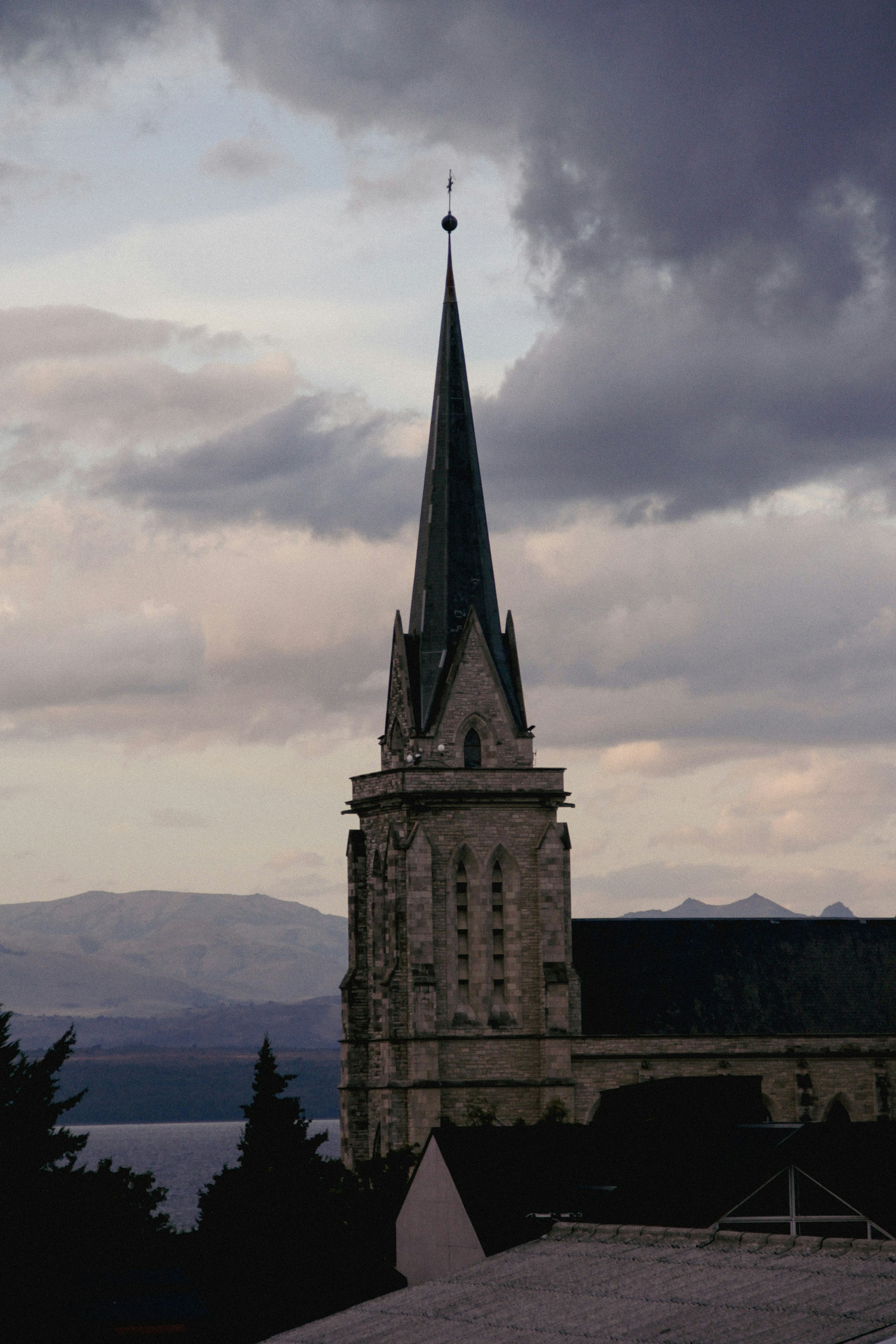 Slate Spire at Dusk: A Chapel Tower Reaches Toward the Clouds