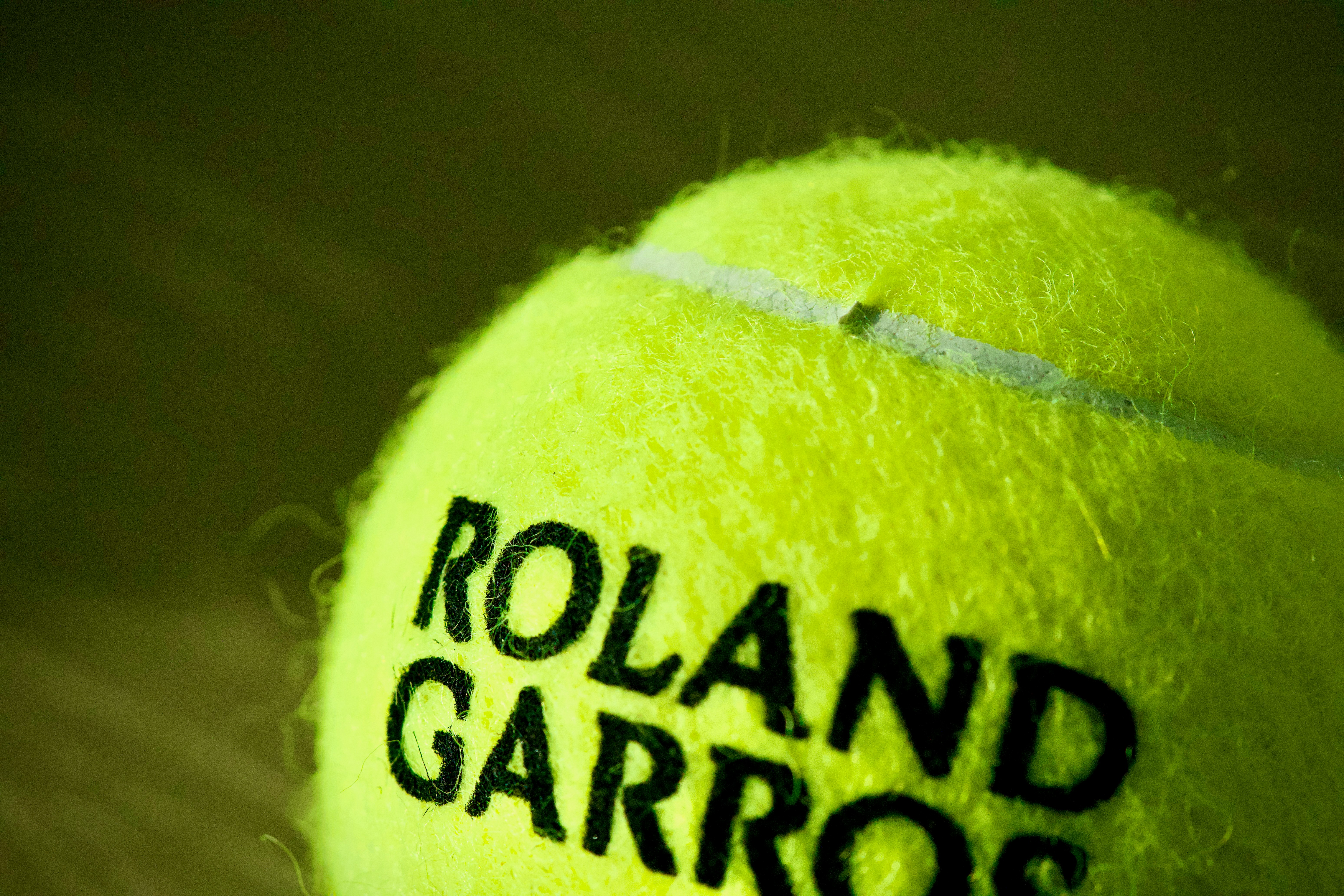 Close-Up of a Tennis Ball with Rolands Garros Branding in Focus