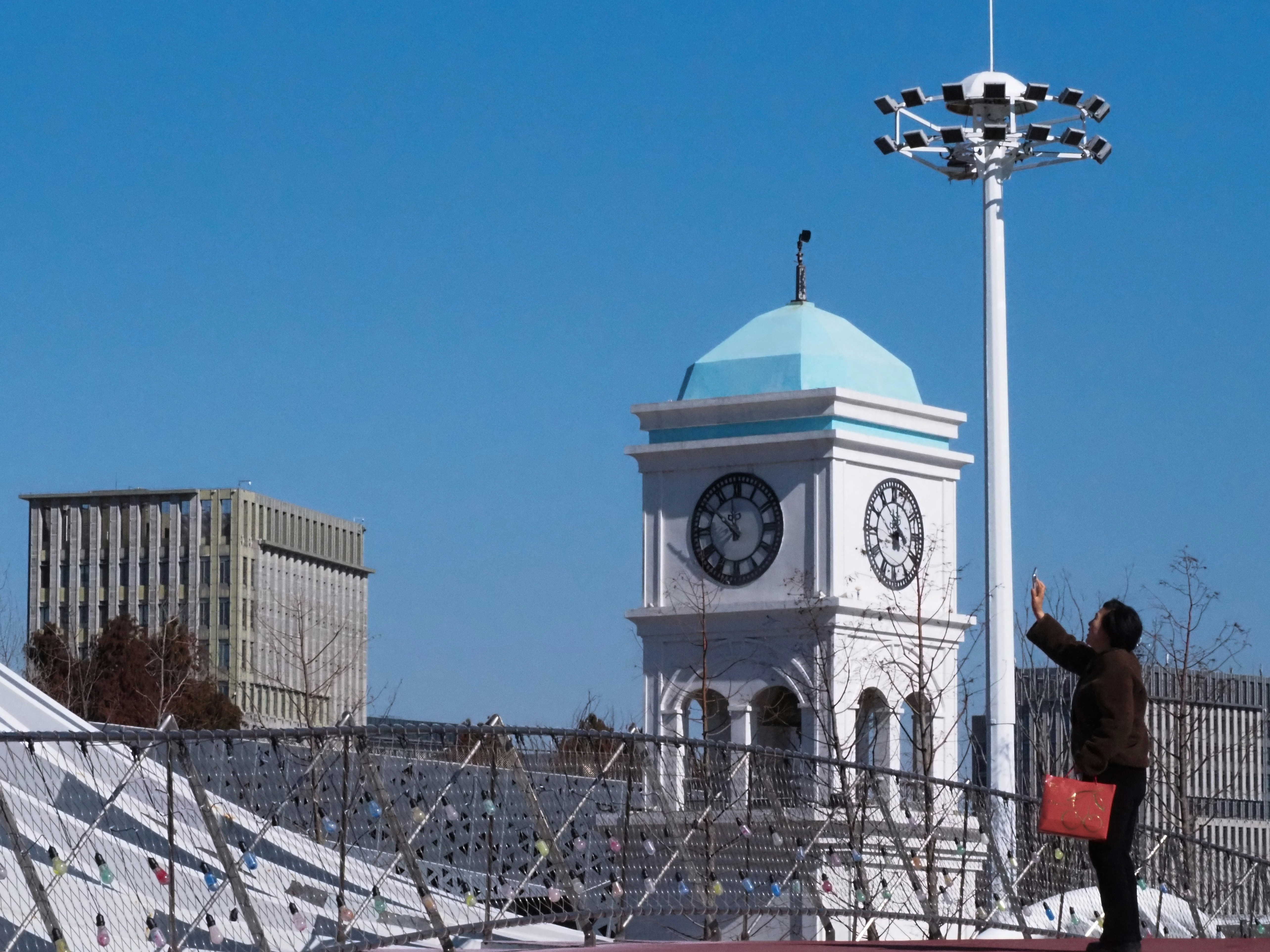Clock Tower Overlook: A Rooftop Scene under a Clear Blue Sky