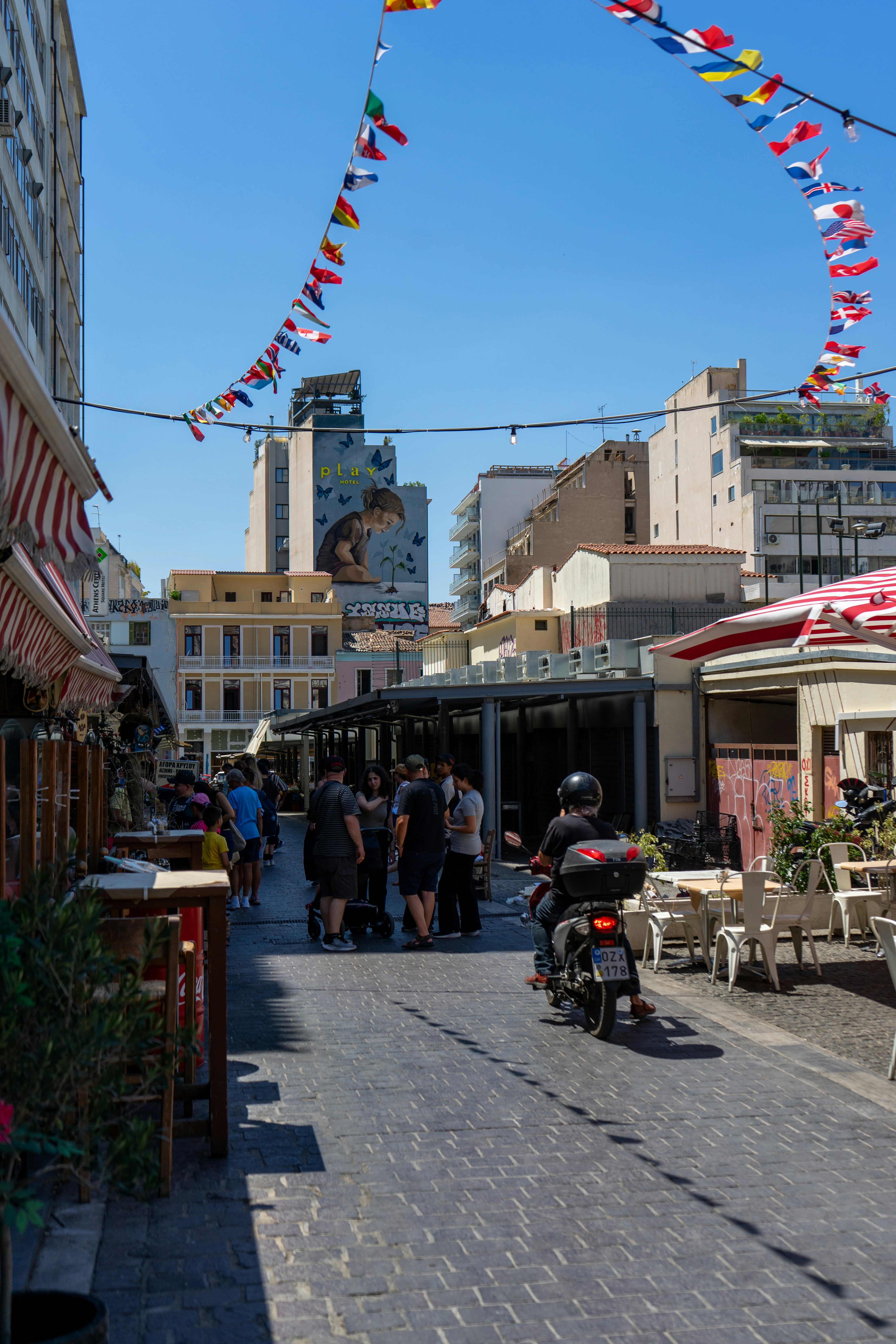Lanterns Over the Cobblestones: A Busy Mediterranean Alley