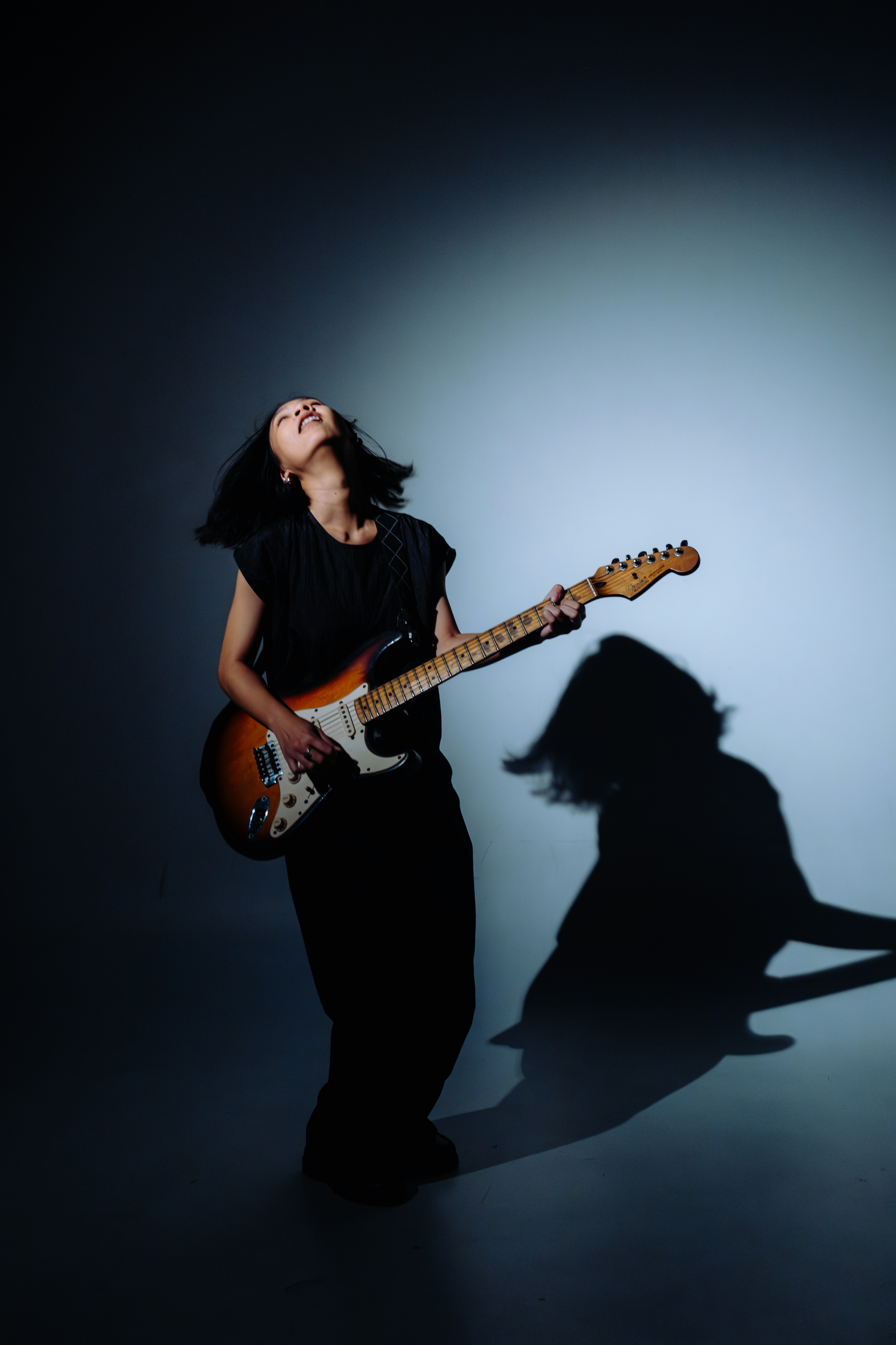 Bassline in the Spotlight: A guitarist in motion under dramatic gradient light