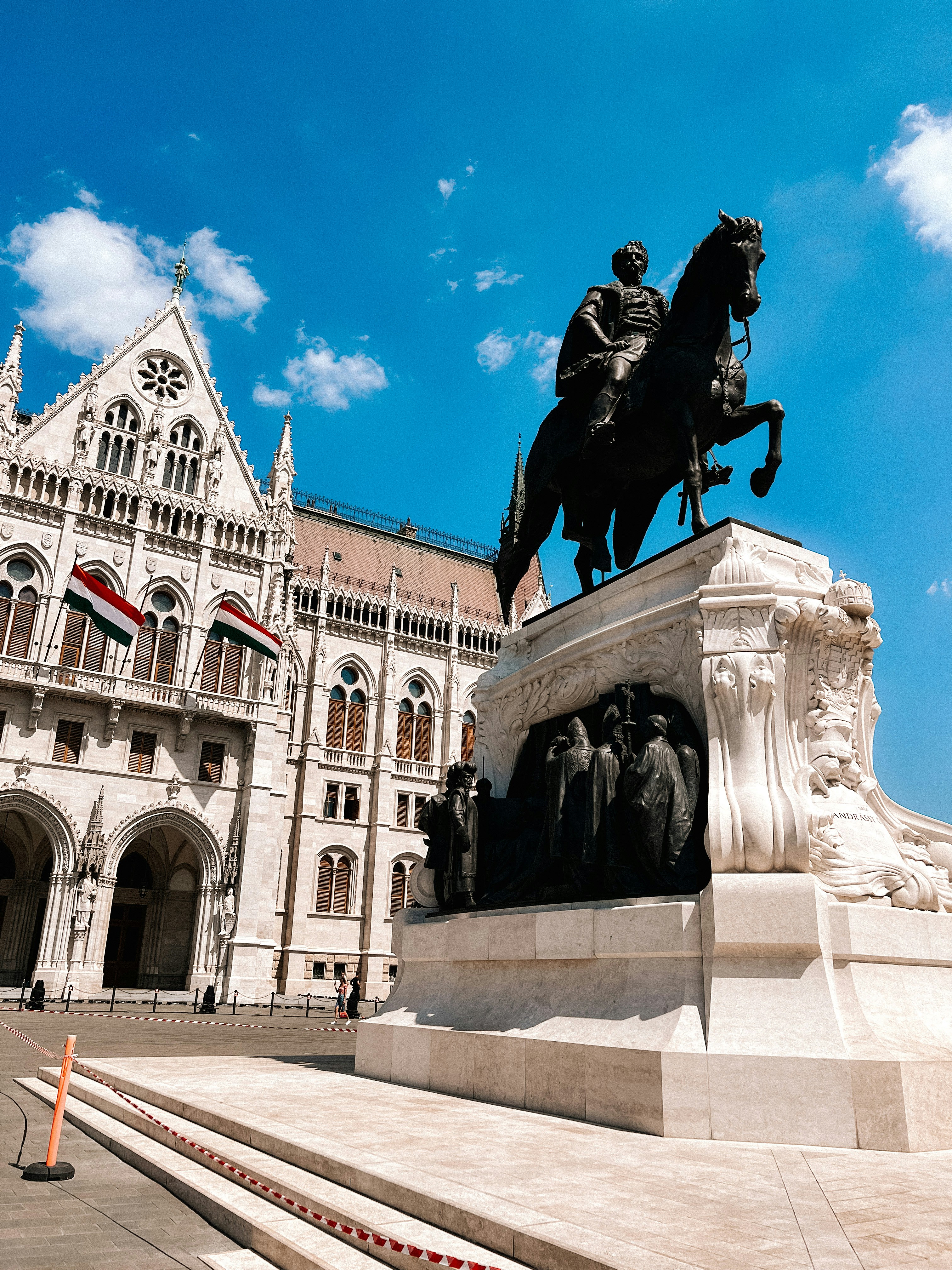 Equestrian Monument and Gothic Facade Beneath a Blue Sky