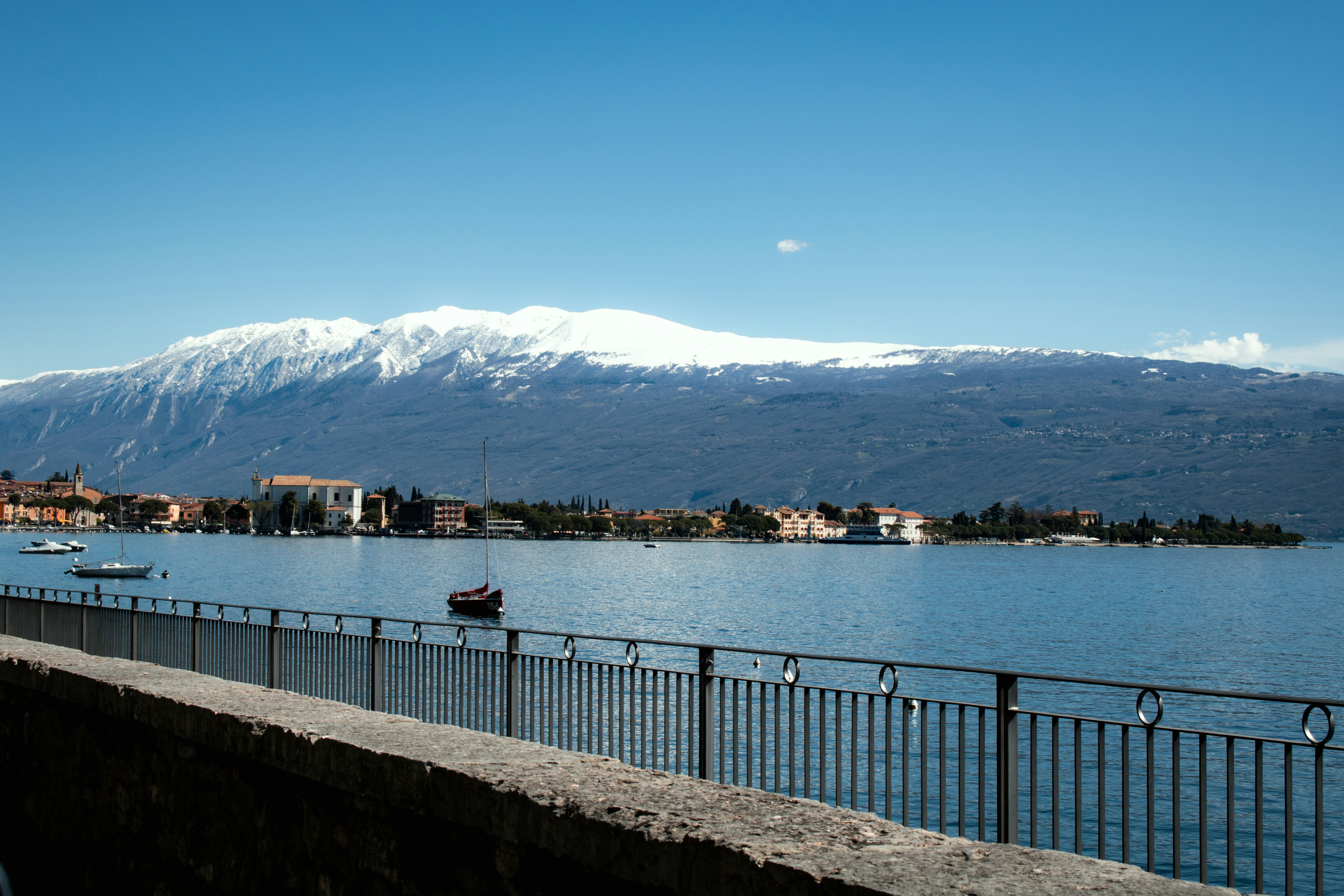 Snow‑capped mountains over a tranquil lakeside town