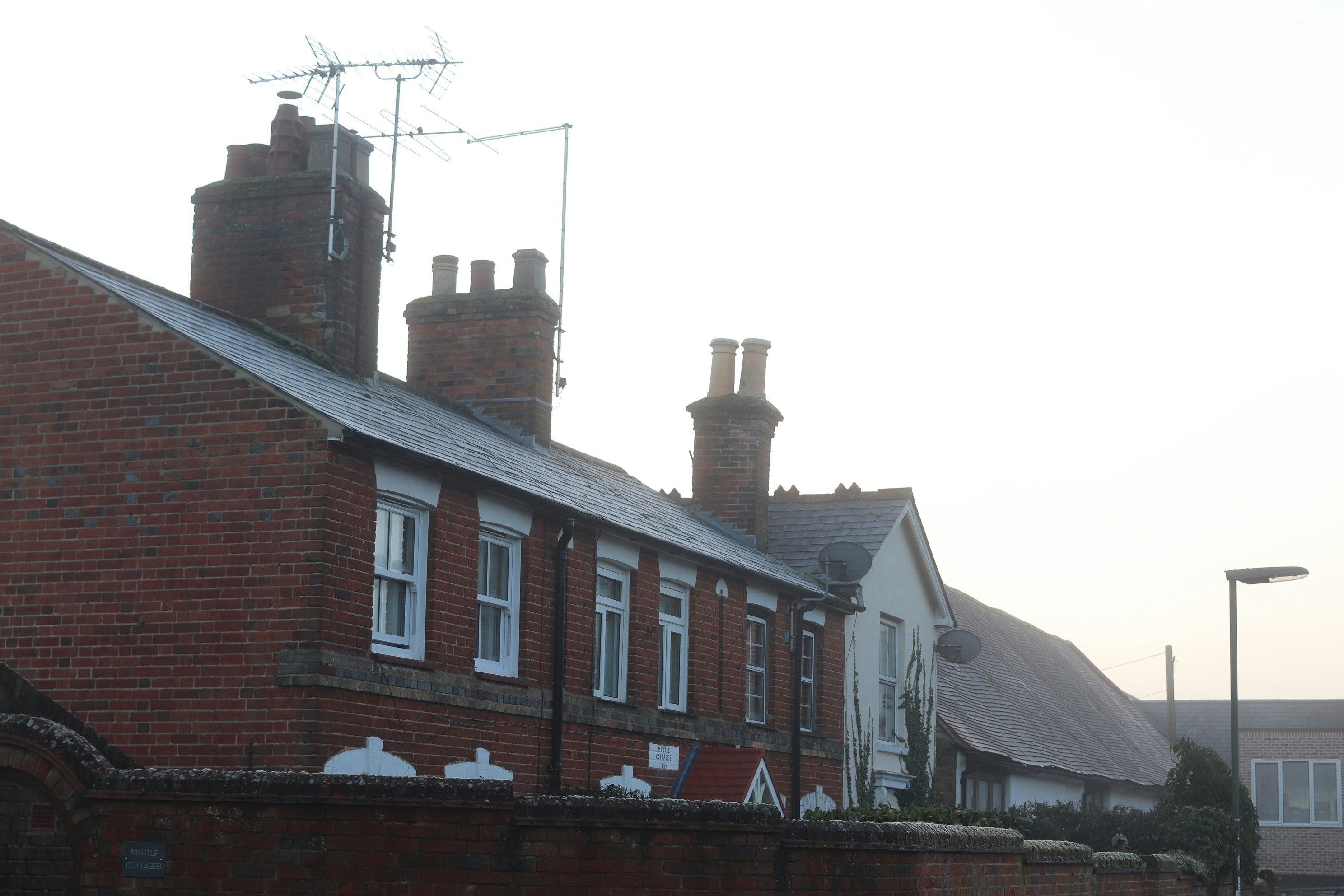 Chimneys and Brick Row Beneath a Quiet Twilight Sky