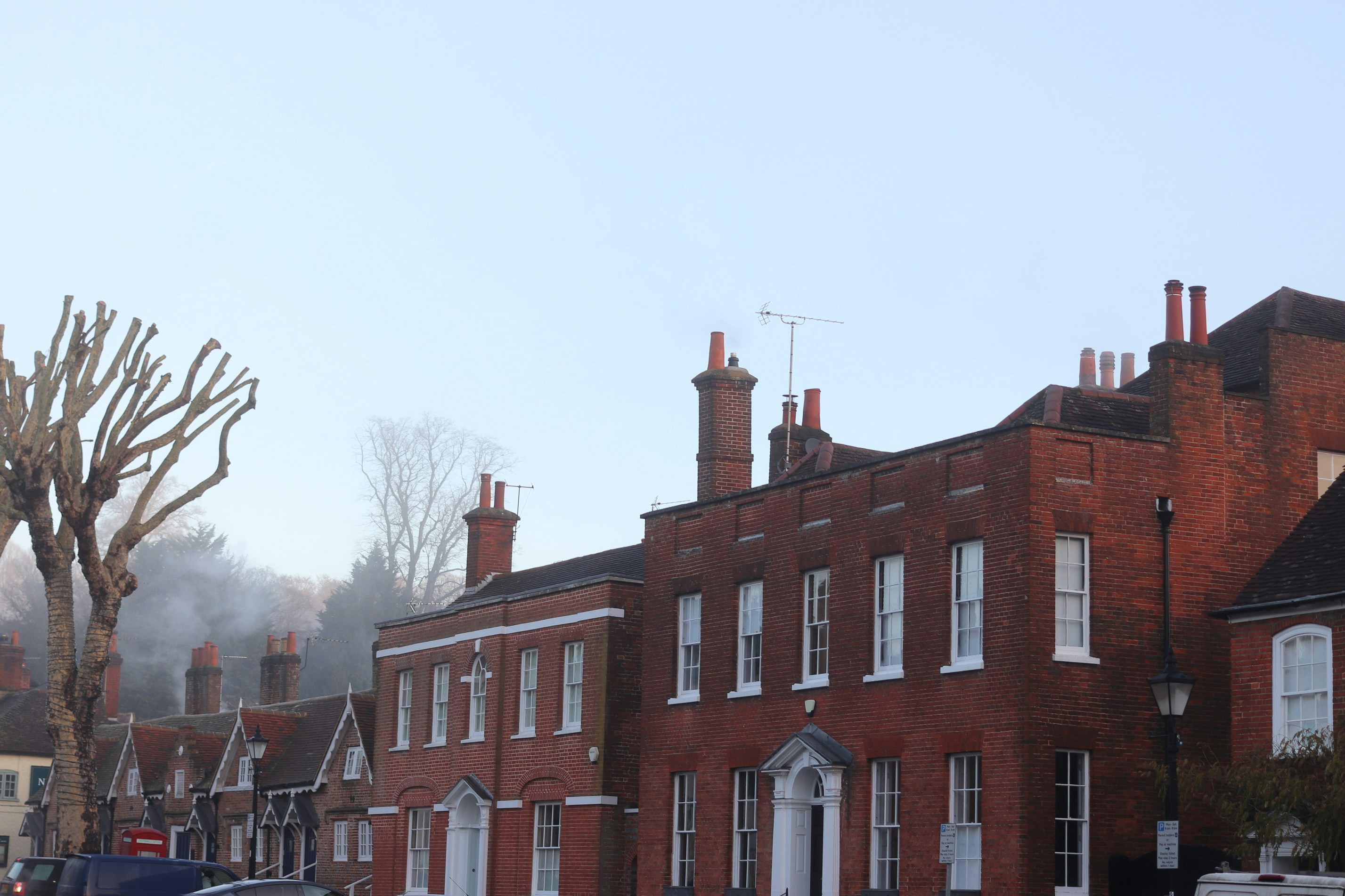 Brick Row with Snow-Trimmed Rooftops Under Clear Morning Sky
