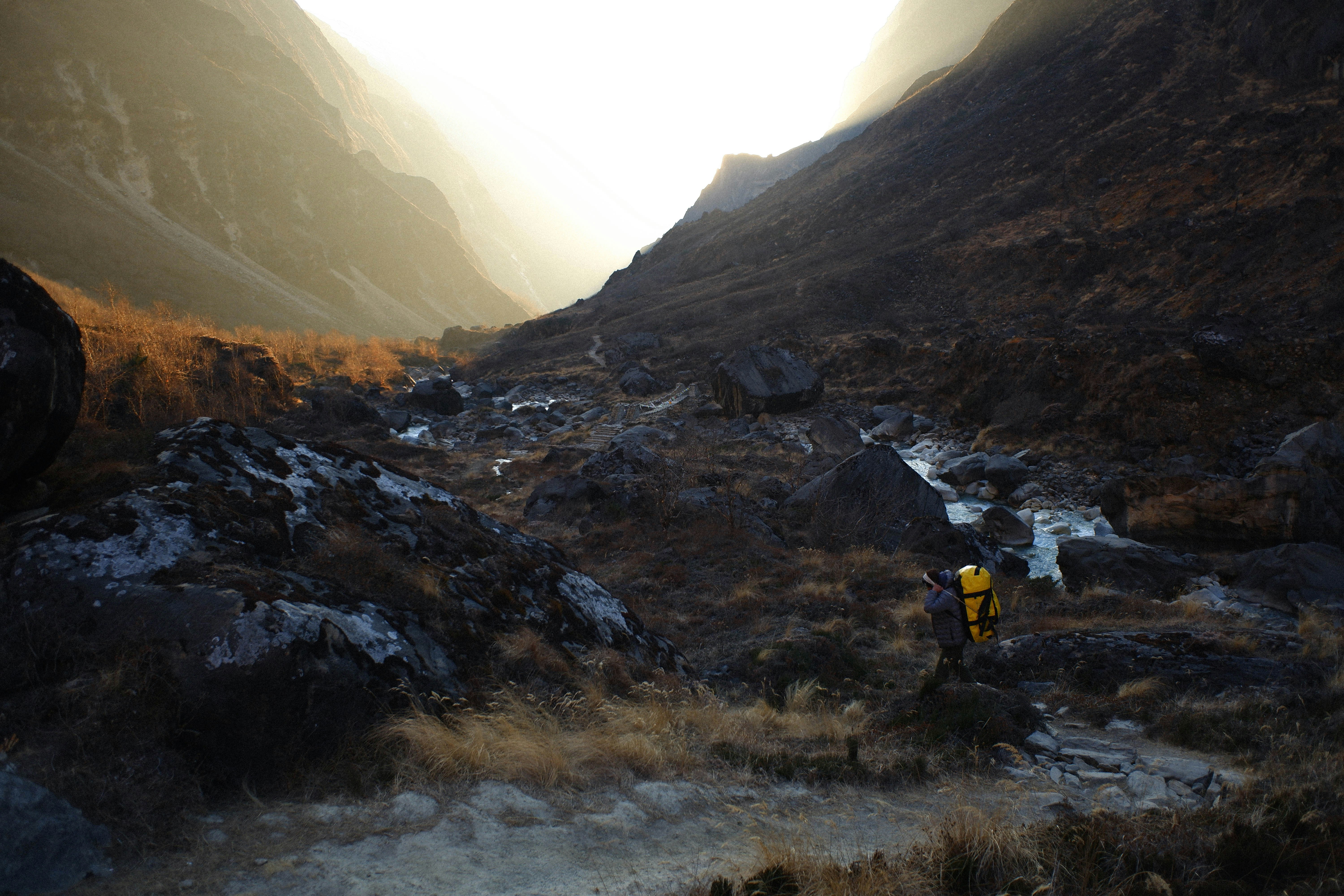 Climber in a Golden Gorge: Narrow Path Through Light and Rock