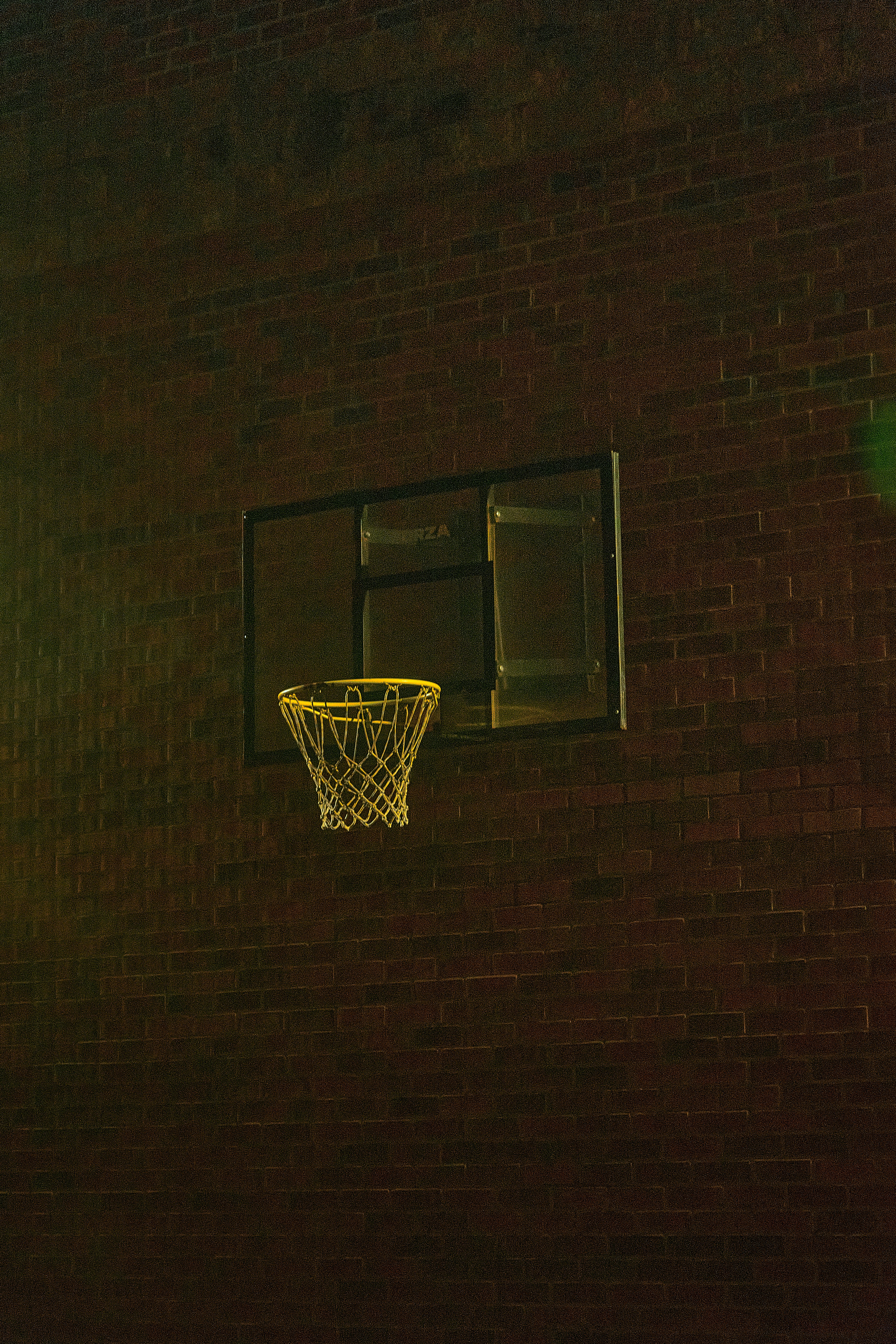 Night Basketball Hoop Against Brick Wall