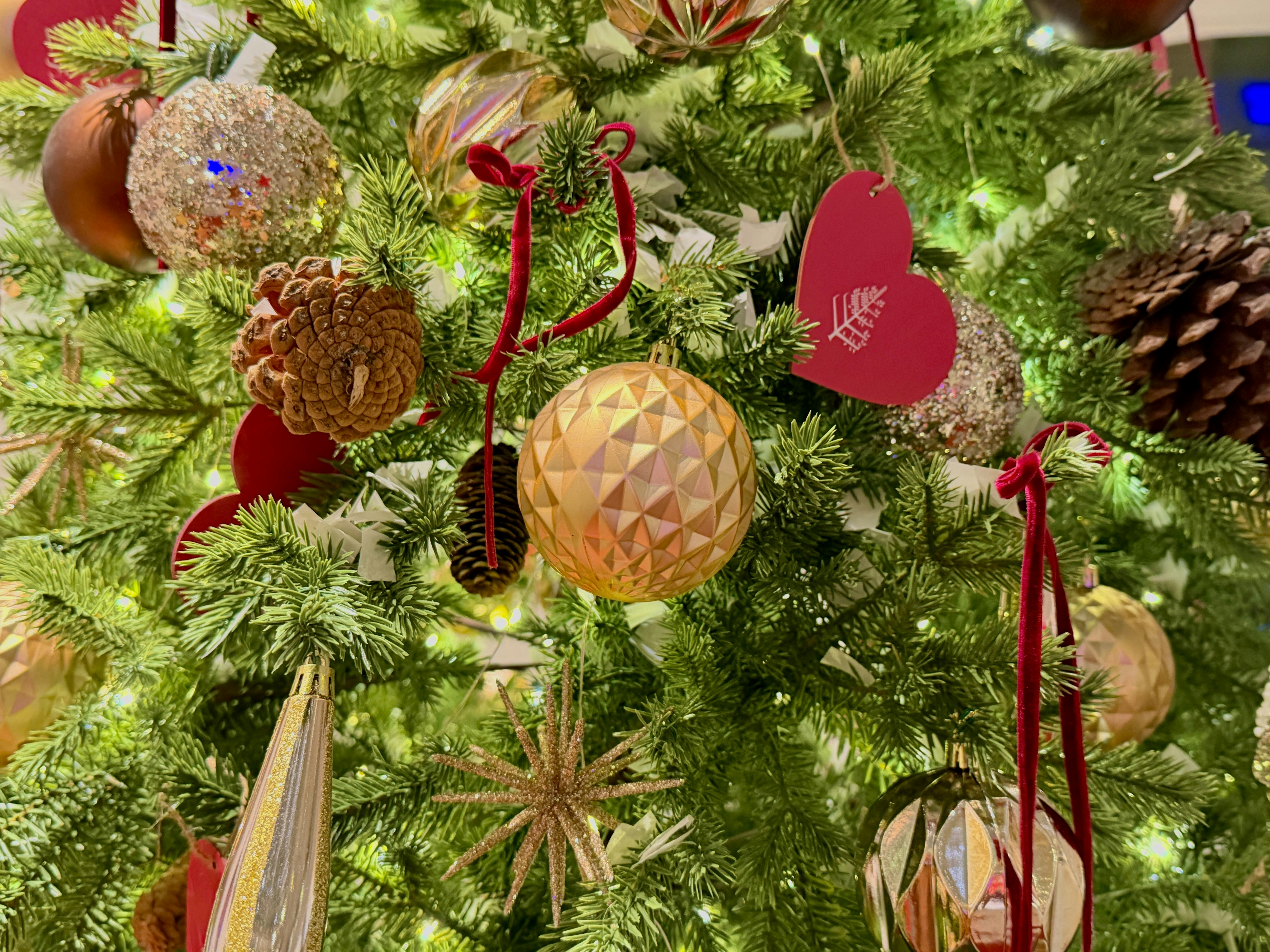Geometric Gold Ornament Amid Festive Pines