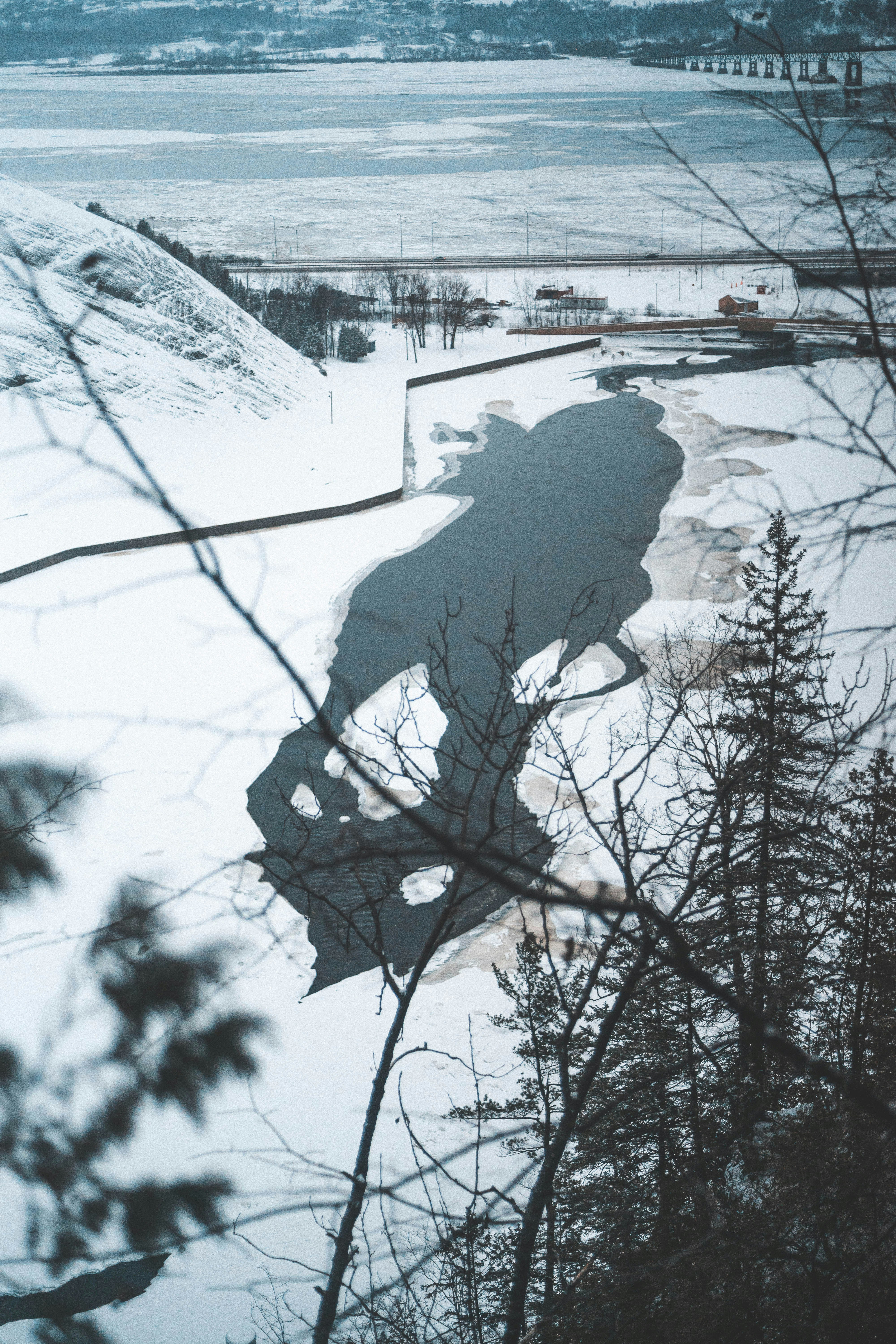 Shadow of Ice: A Frozen Channel Meanders Through Snow