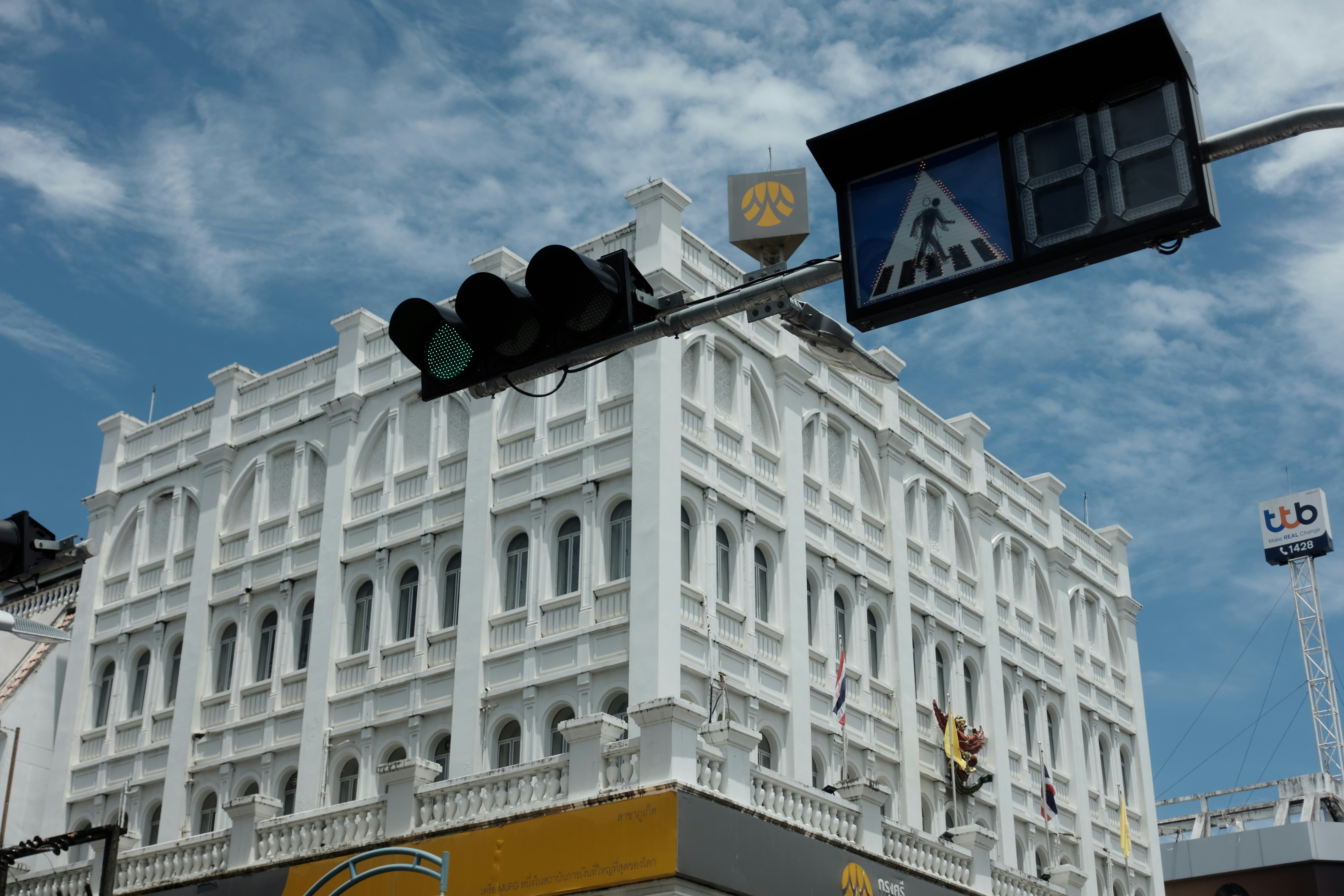 White-washed fortress: a historic corner building under a modern traffic junction