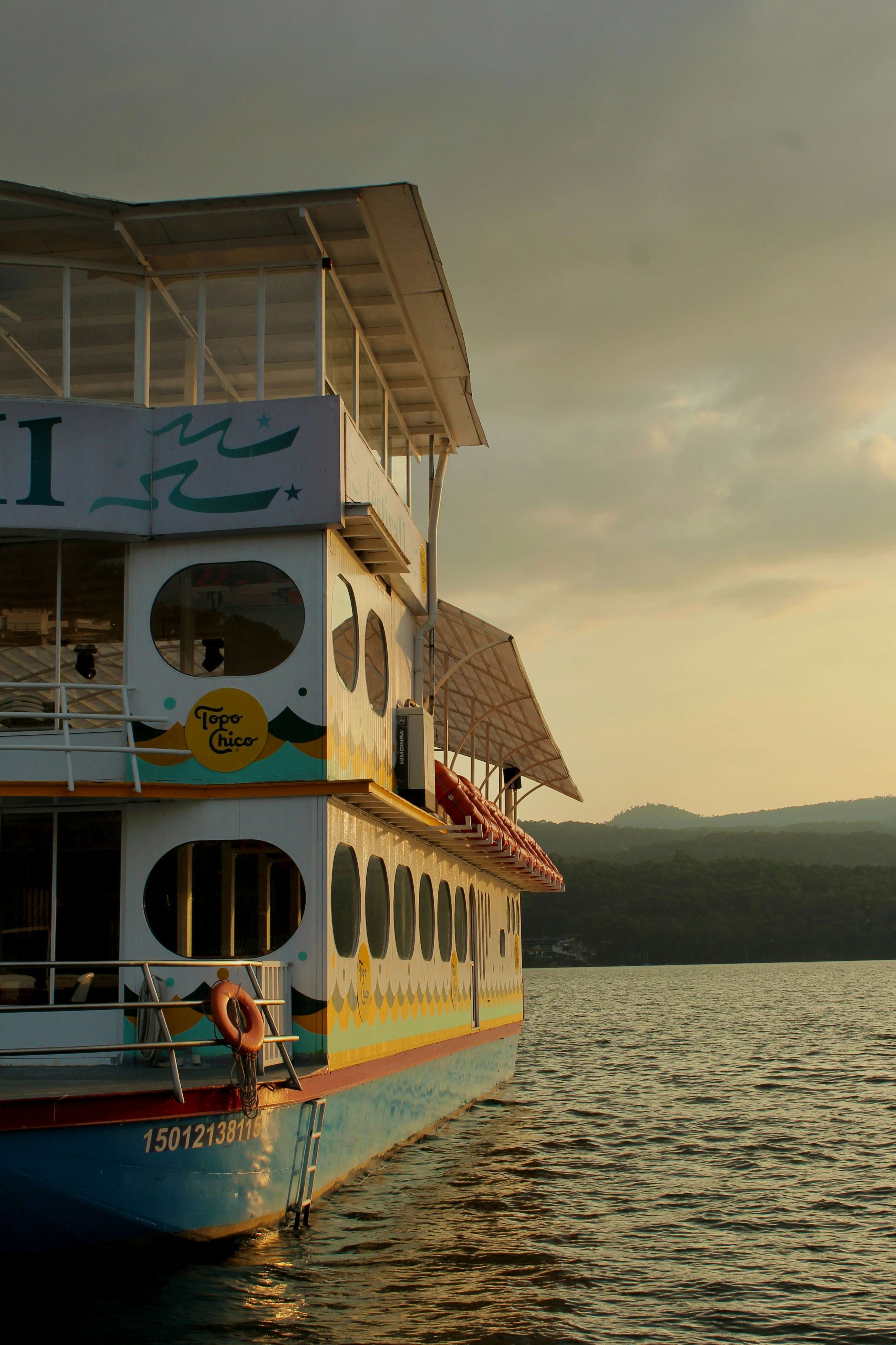 Sunlit Prow: A River Boat at Dusk with Circular Windows