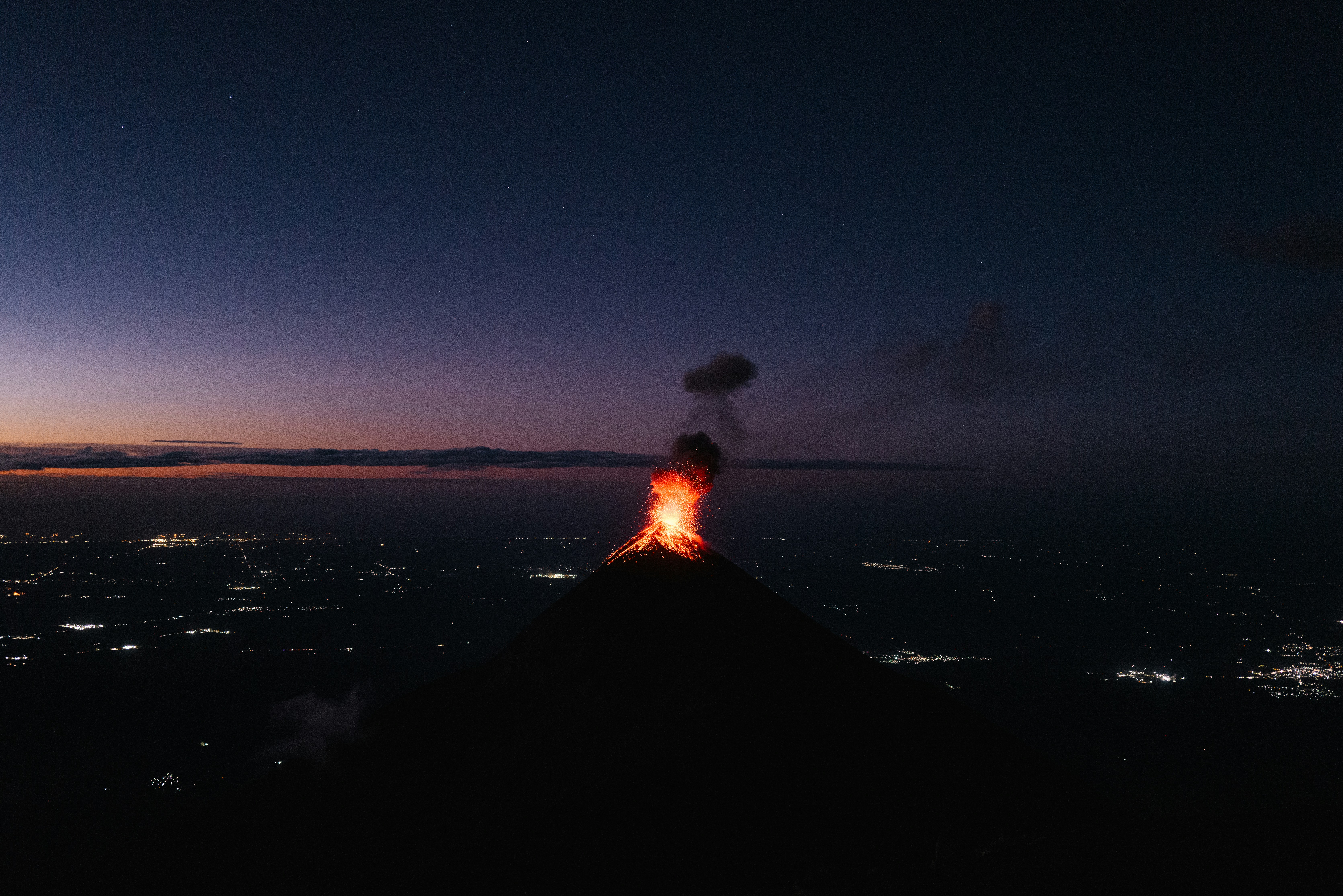 Midnight Eruption: A Silent Summit Piercing the Night Sky