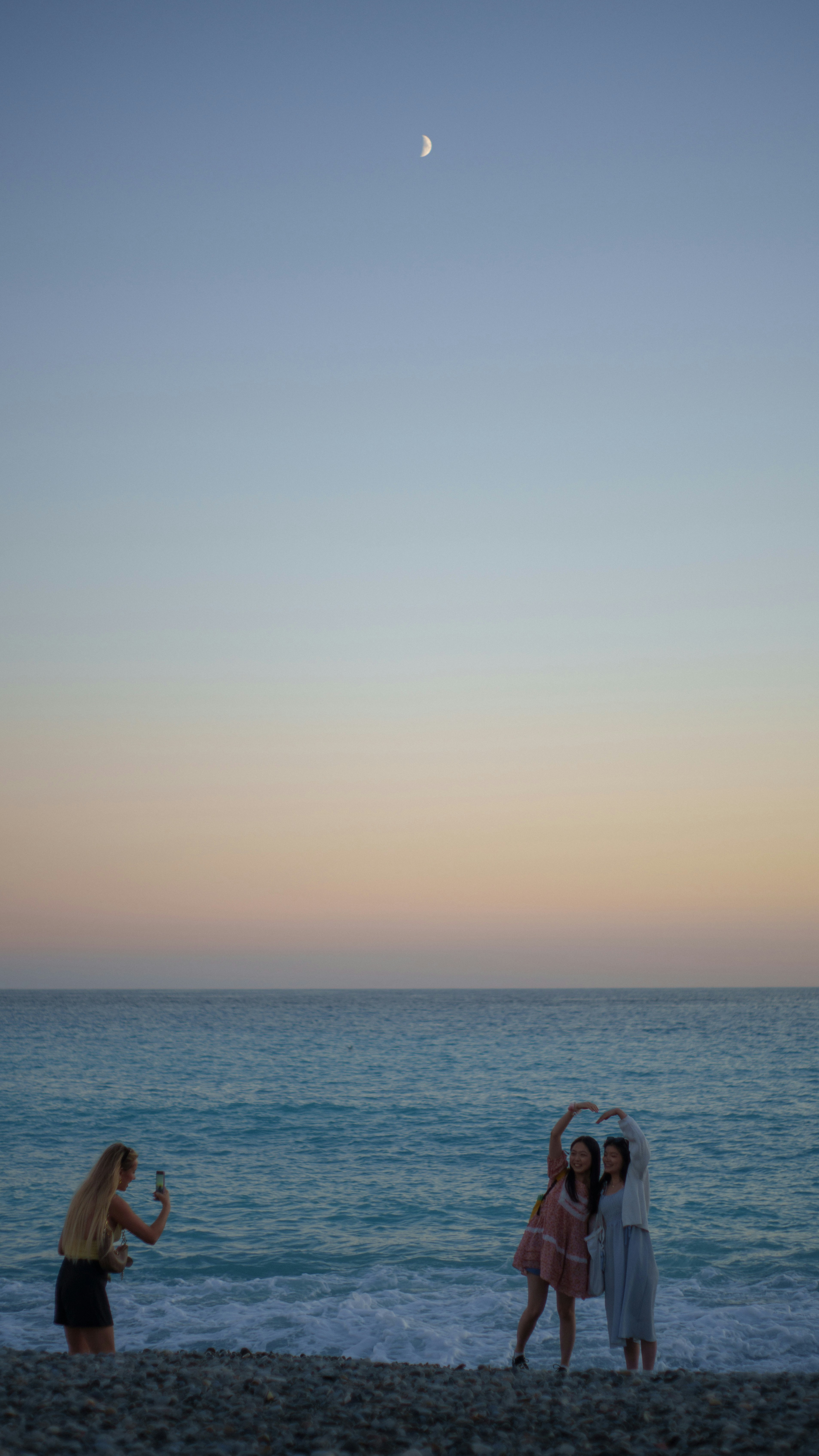 Sunset by the Sea: A Triad of Friends by the Shore