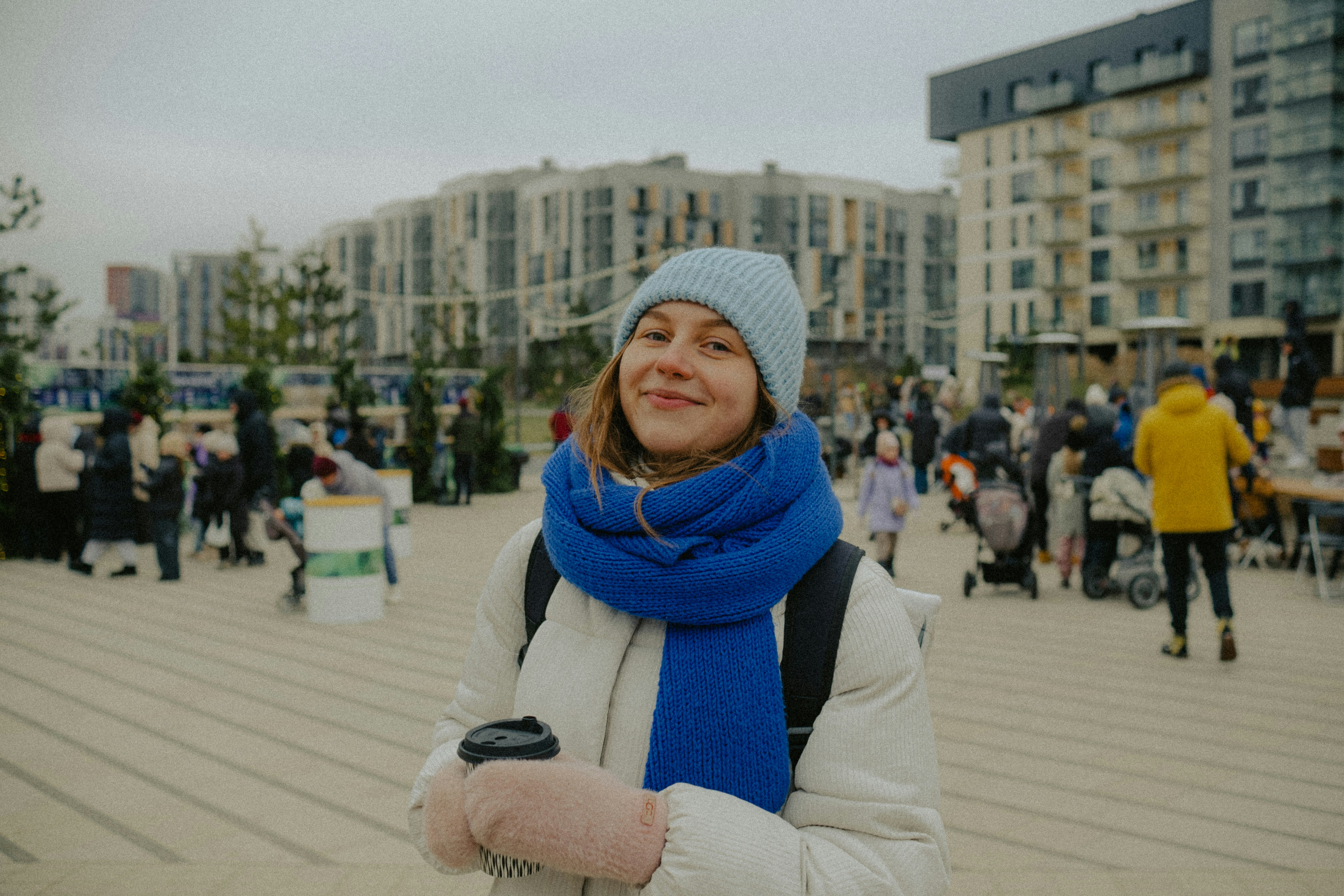Circle of Winter Warmth: A Smiling Photographer in a City Square