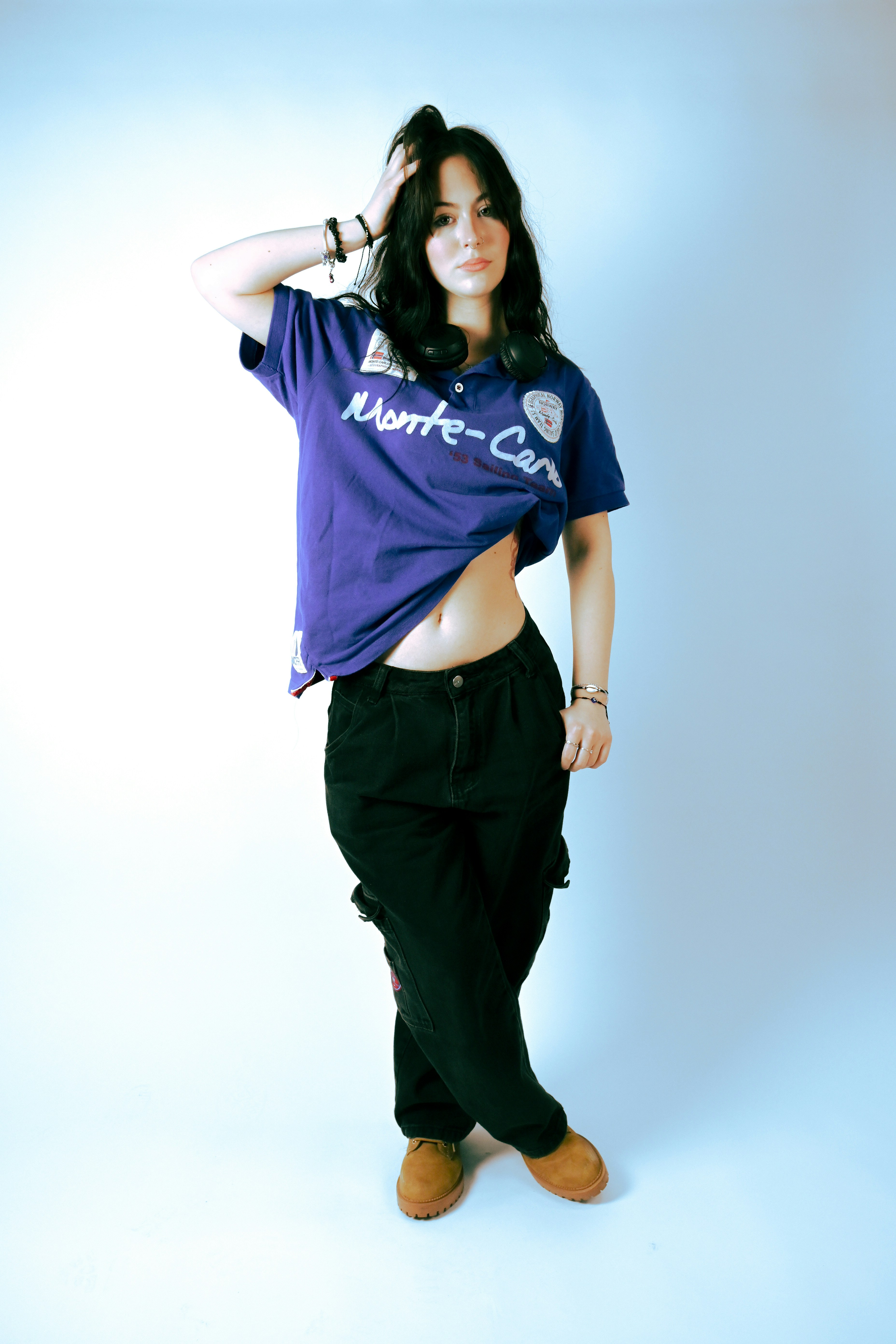 Purple tee, black cargo pants: a casual portrait with a confident tilt