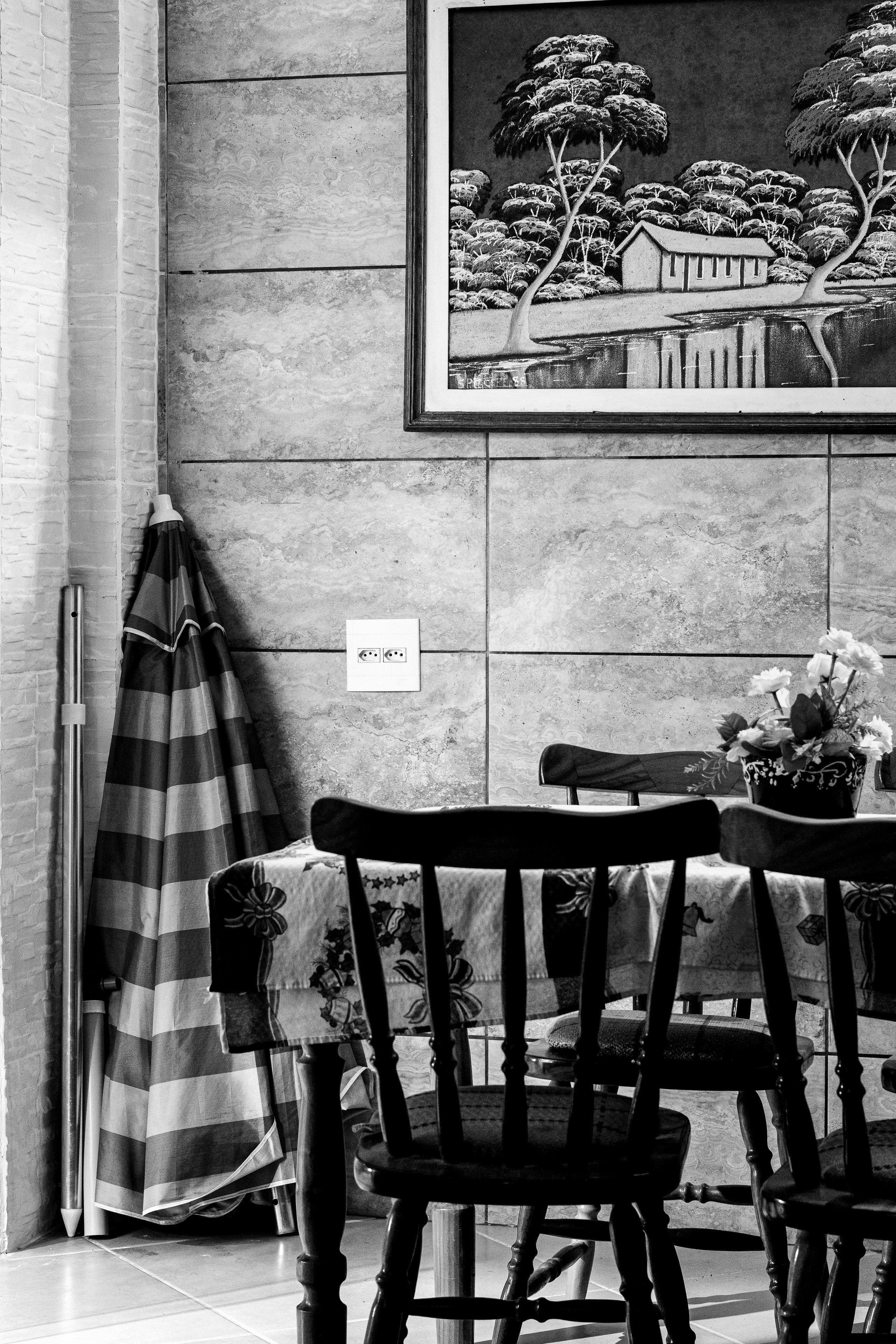 Monochrome Corner: A Quiet Dining Nook with Striped Umbrella