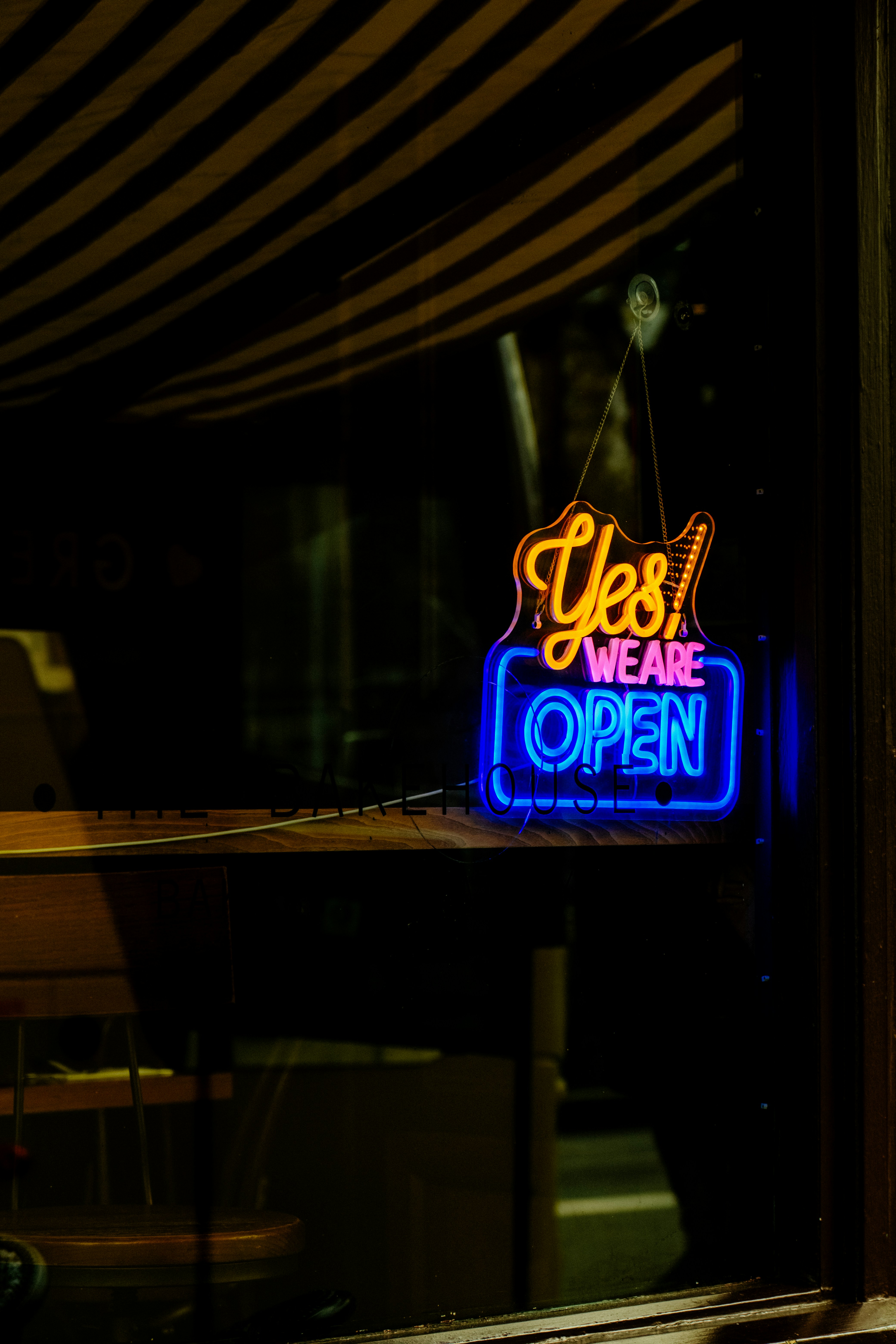 Neon Signage in a Dim Streetfront Window