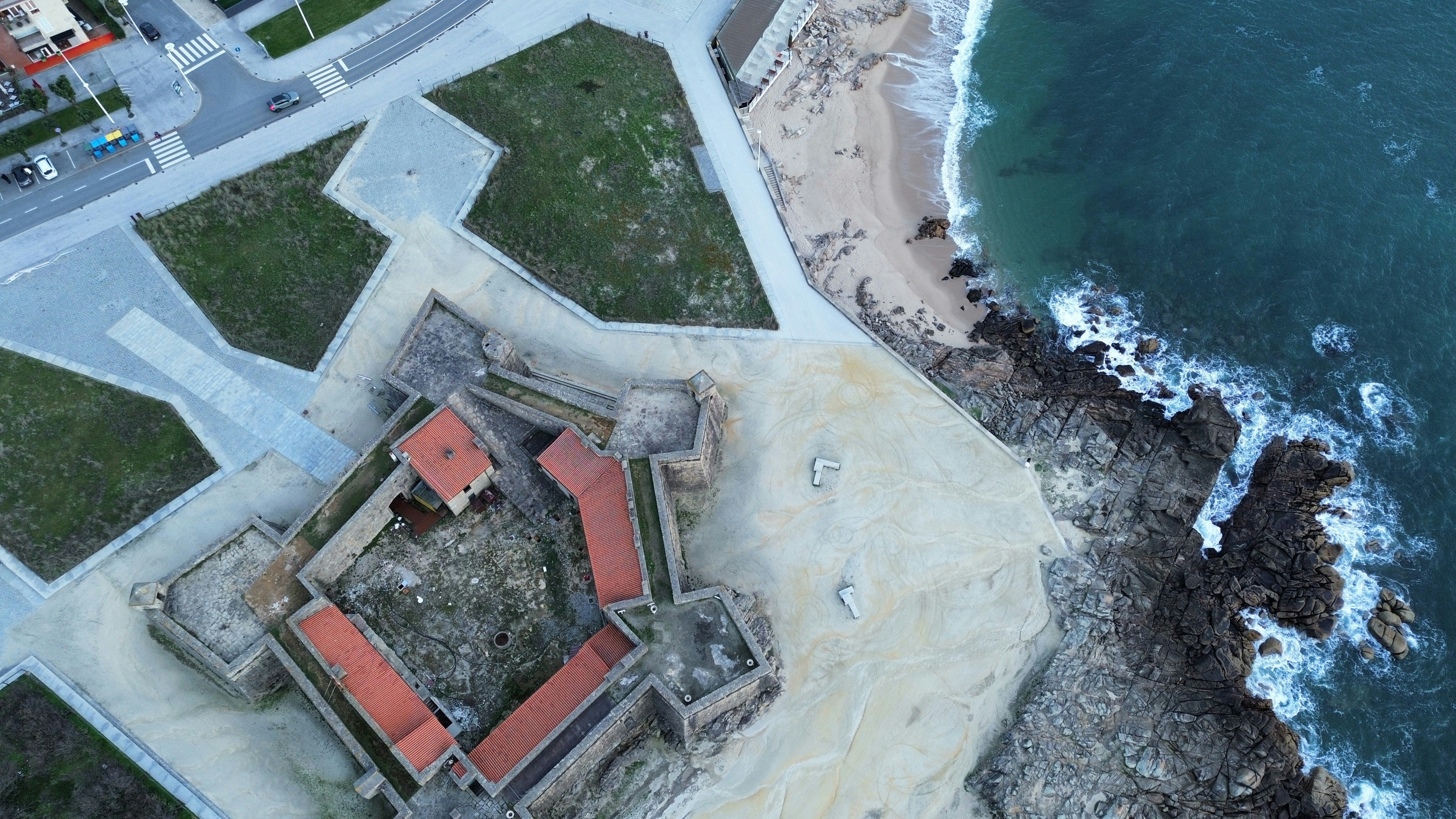  Fortress on the Cliffs: Aerial view of coastal fortress and shoreline