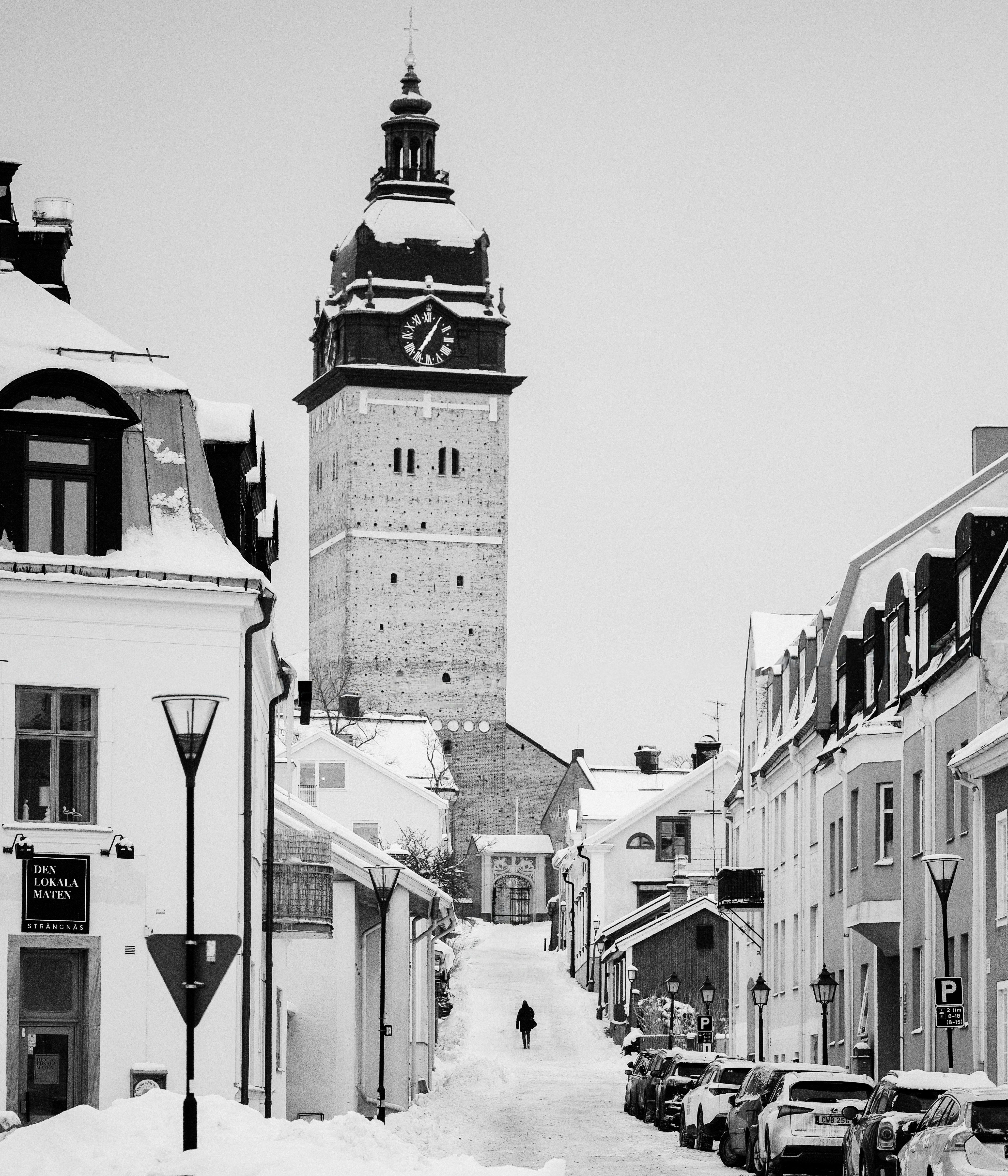 Towering Clock and Snowbound Street to the City