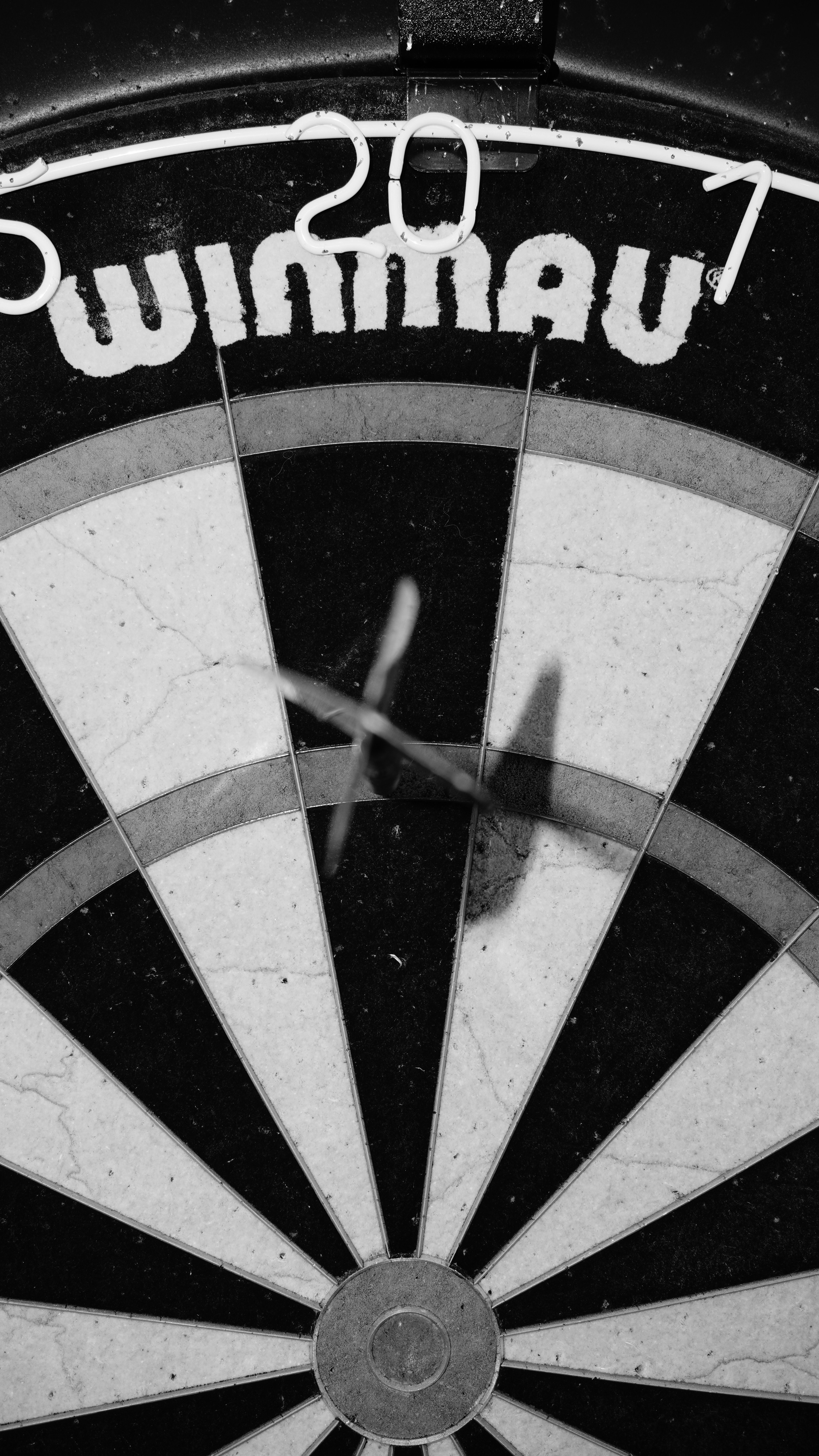 Bullseye in Black and White: A Dartboard's Center Shadow