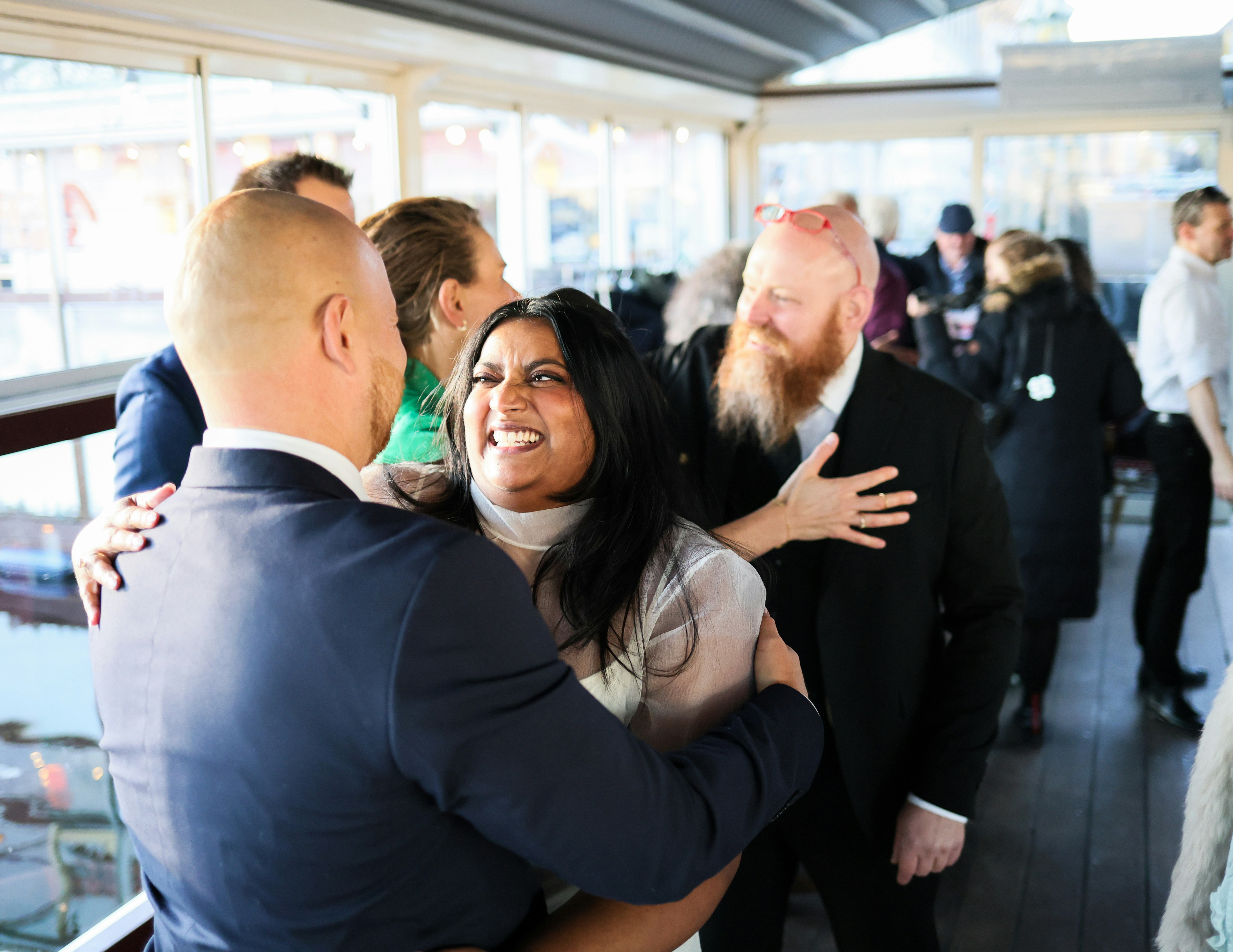 Joyful Reunion: Embrace on a Sunlit Terrace