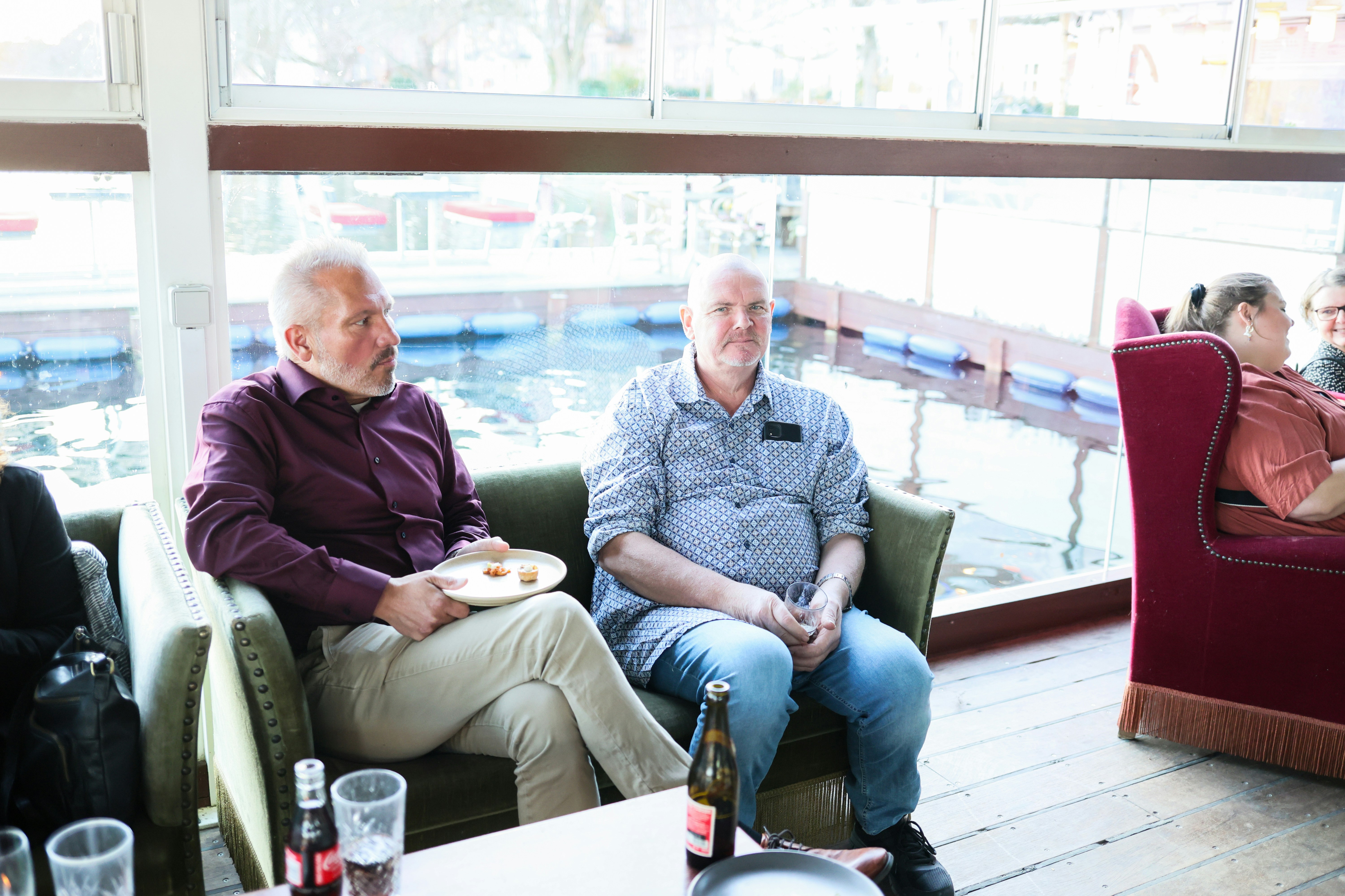 Conversations by the Window: Friends in a Waterfront Lounge
