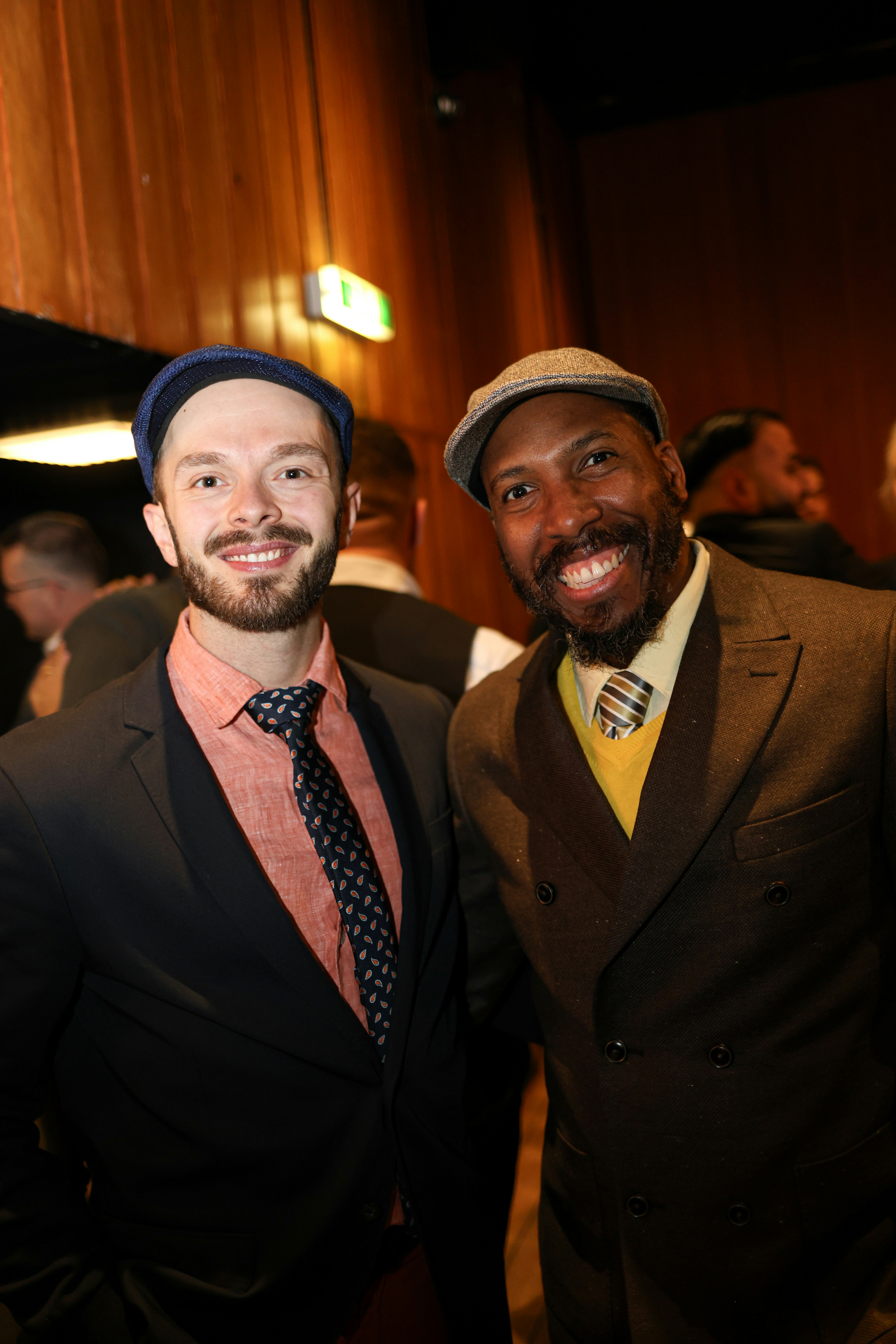 Two Gentlemen in Evening Attire Share a Warm Moment