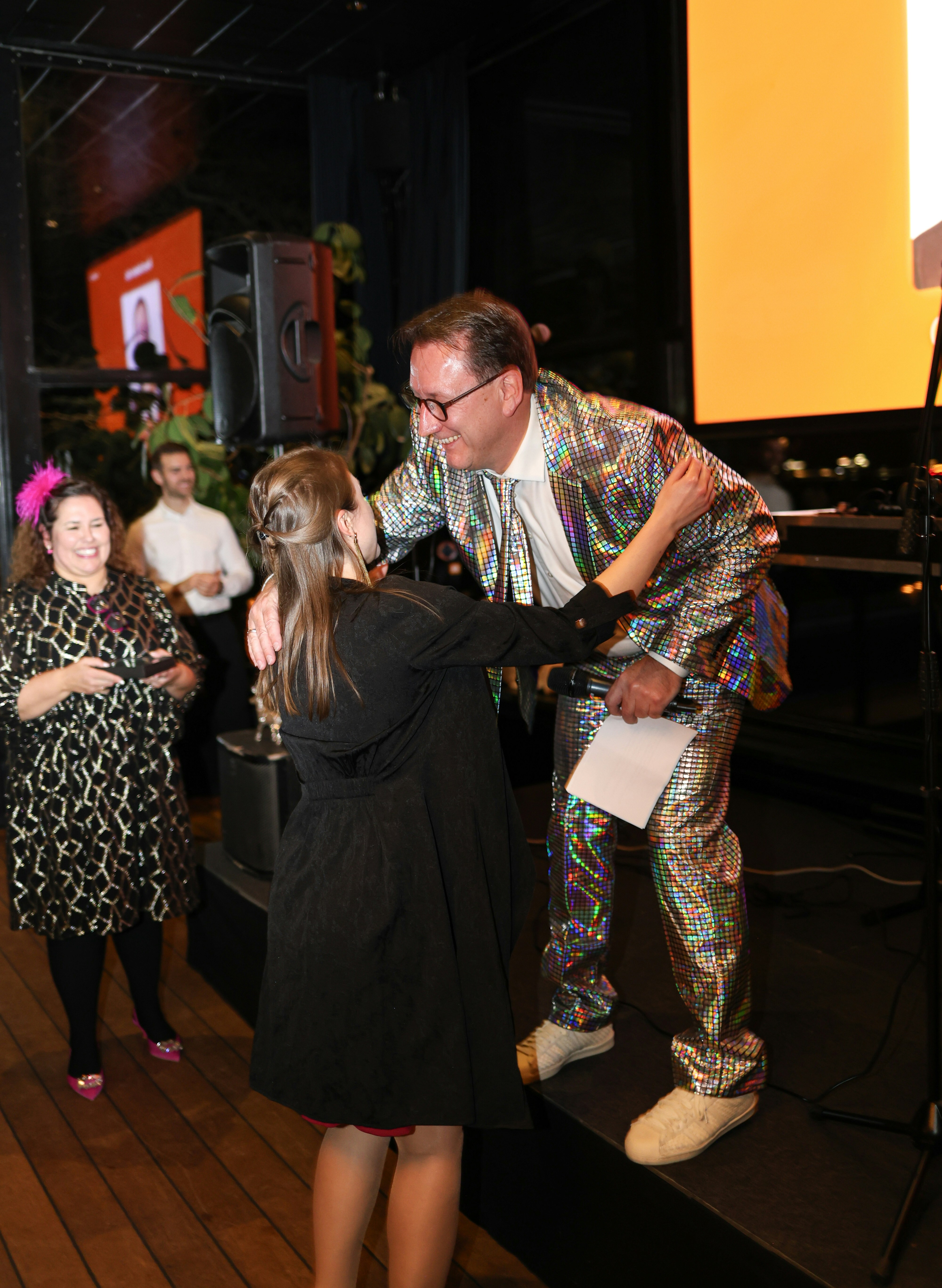 Handshake on the Stage: A Velvet-Suited Moment of Celebration
