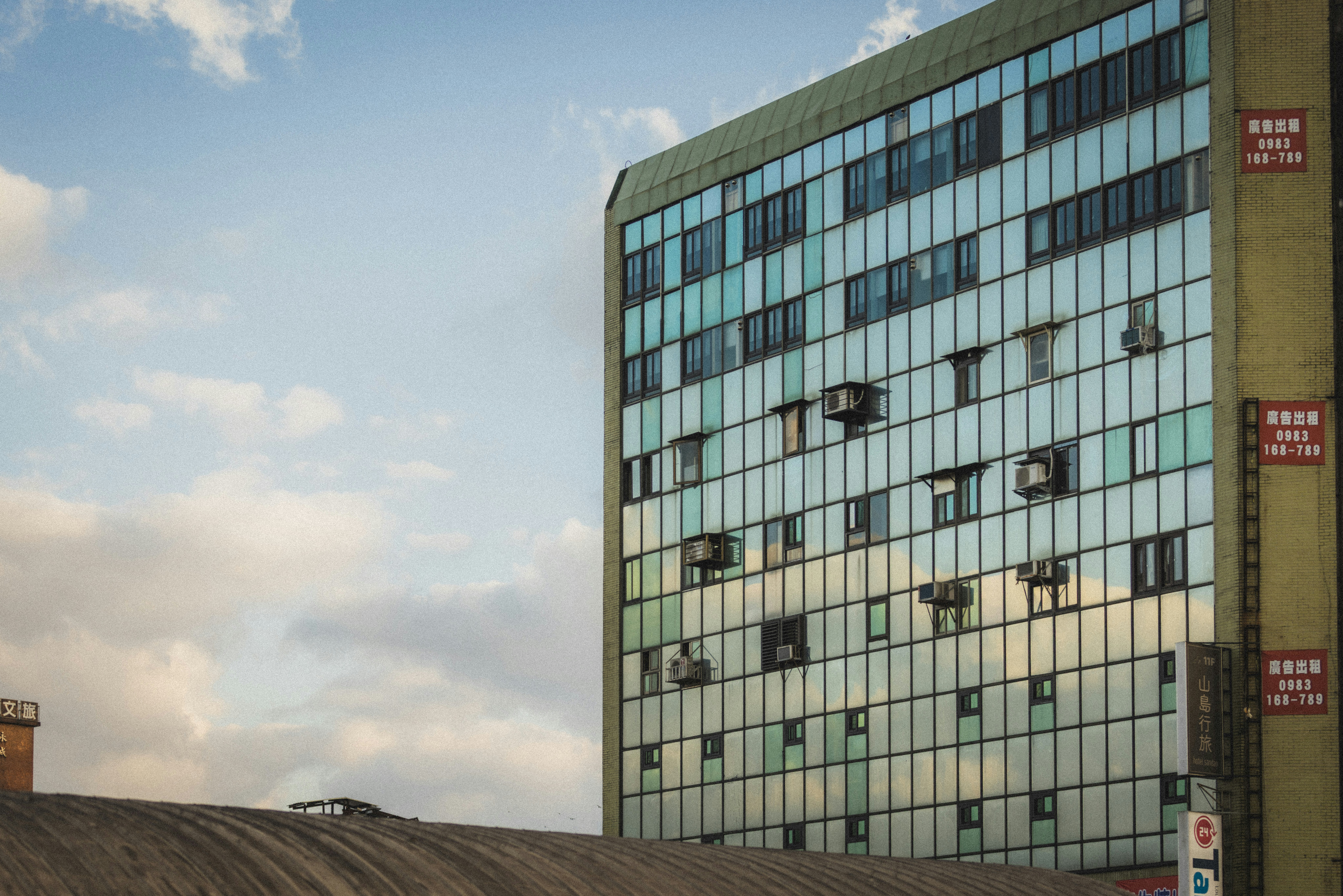 Glass Facade Reflections on a City Block