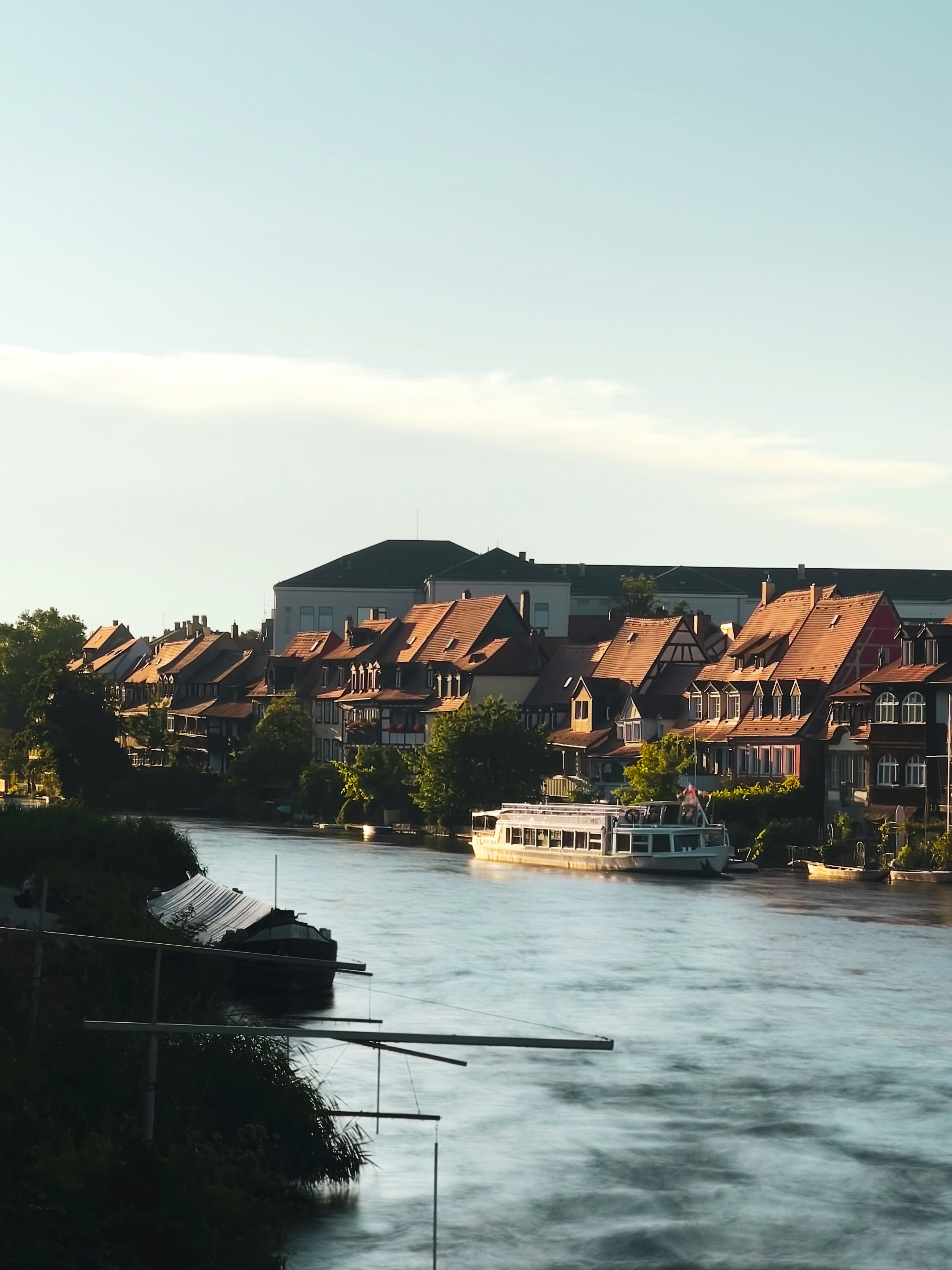 Waterfront Village Drift: Boats, Brick Gables, and Distant River