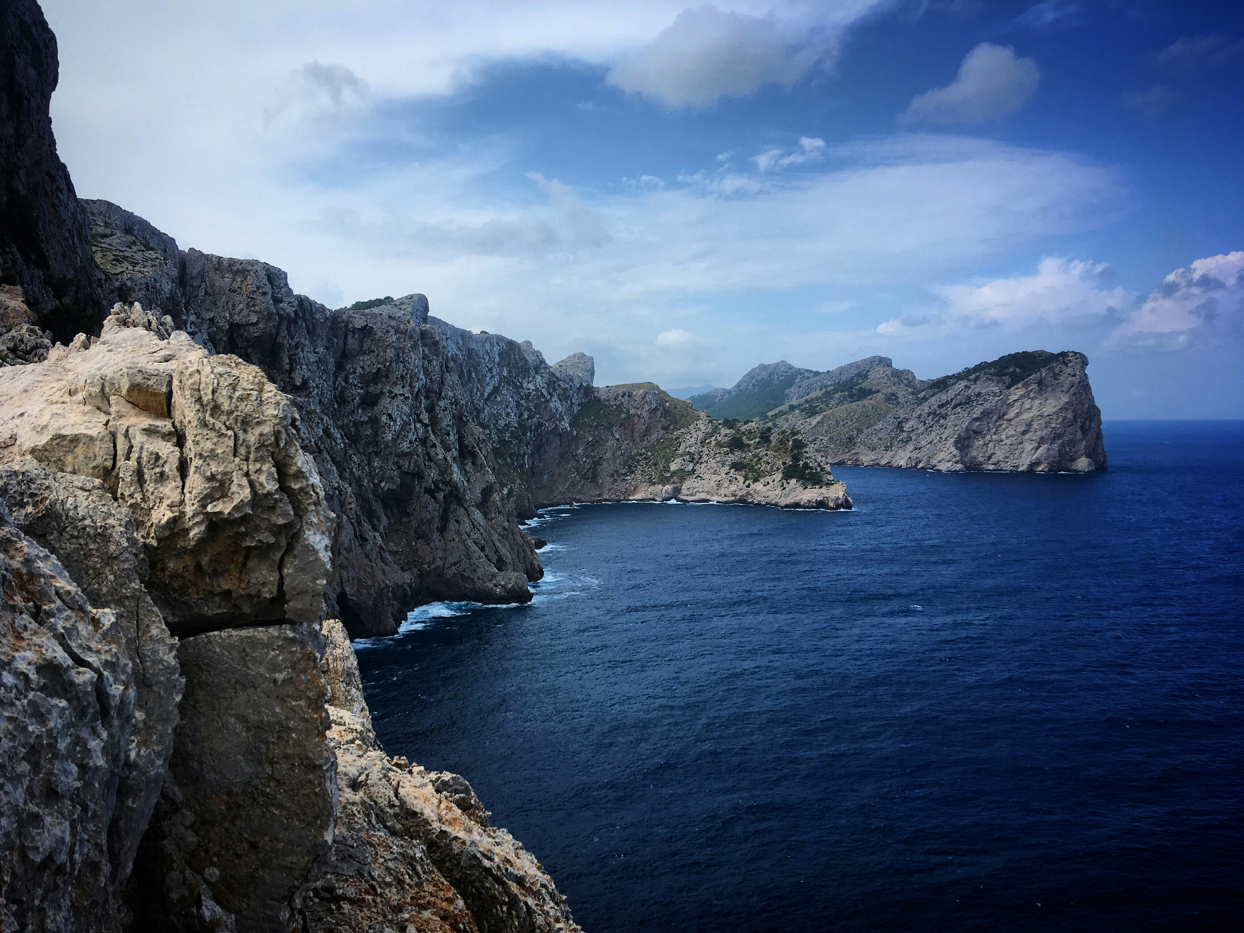 Cliffside Horizon: Sunlit Rock and Azure Sea