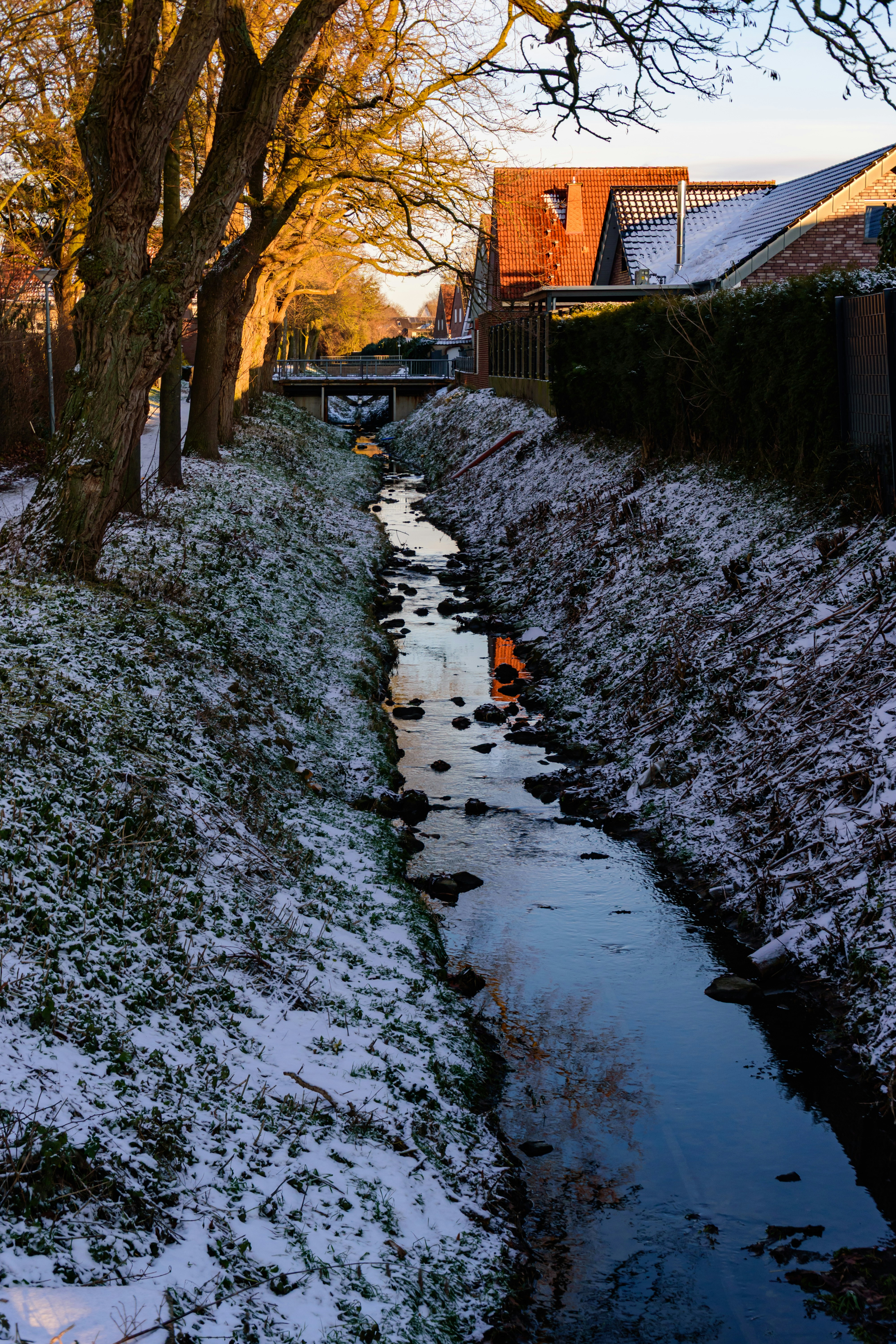 Winter Stream Through a Suburban Channel at Sunrise