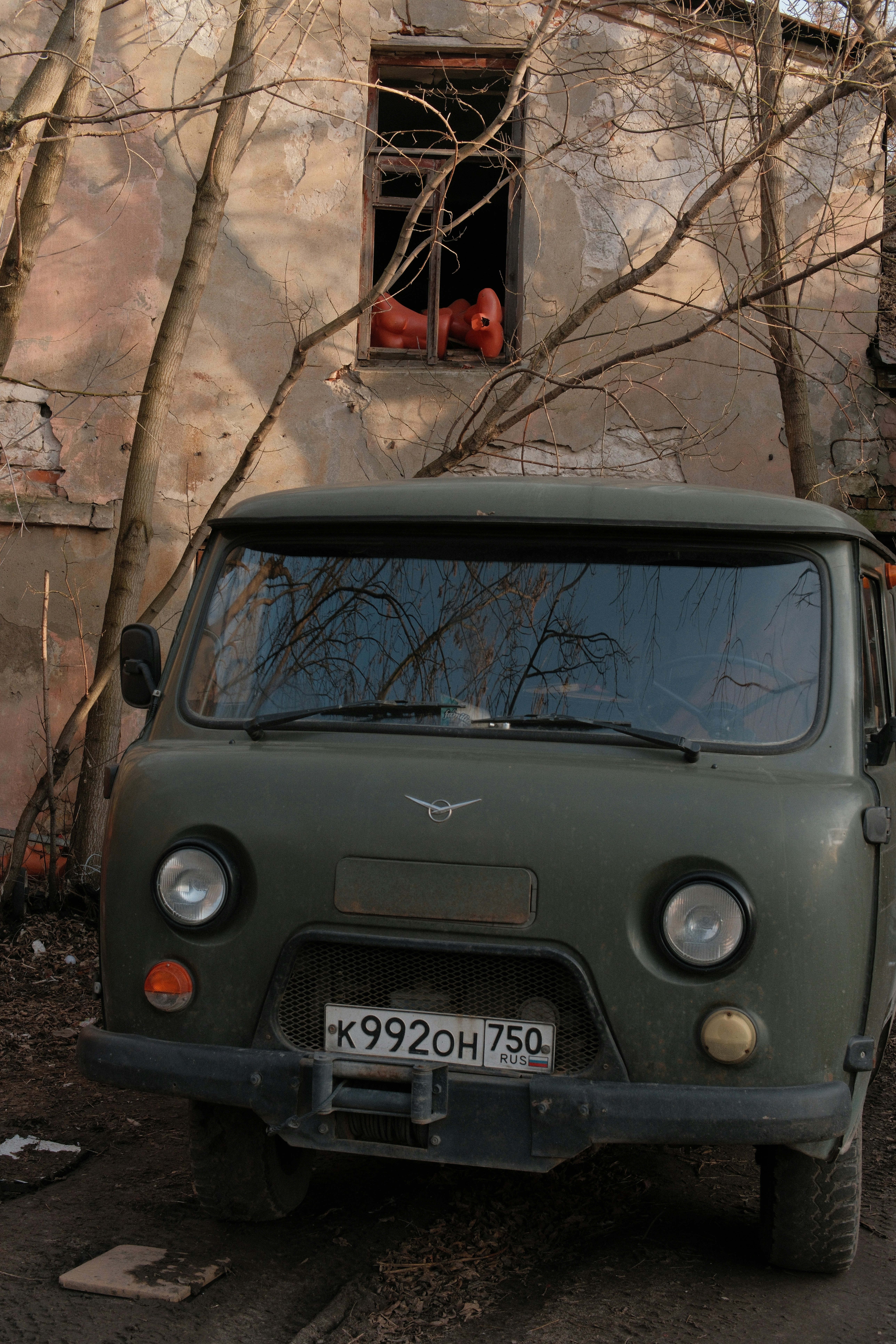 Old Green Van Gazes from a Cracked Window