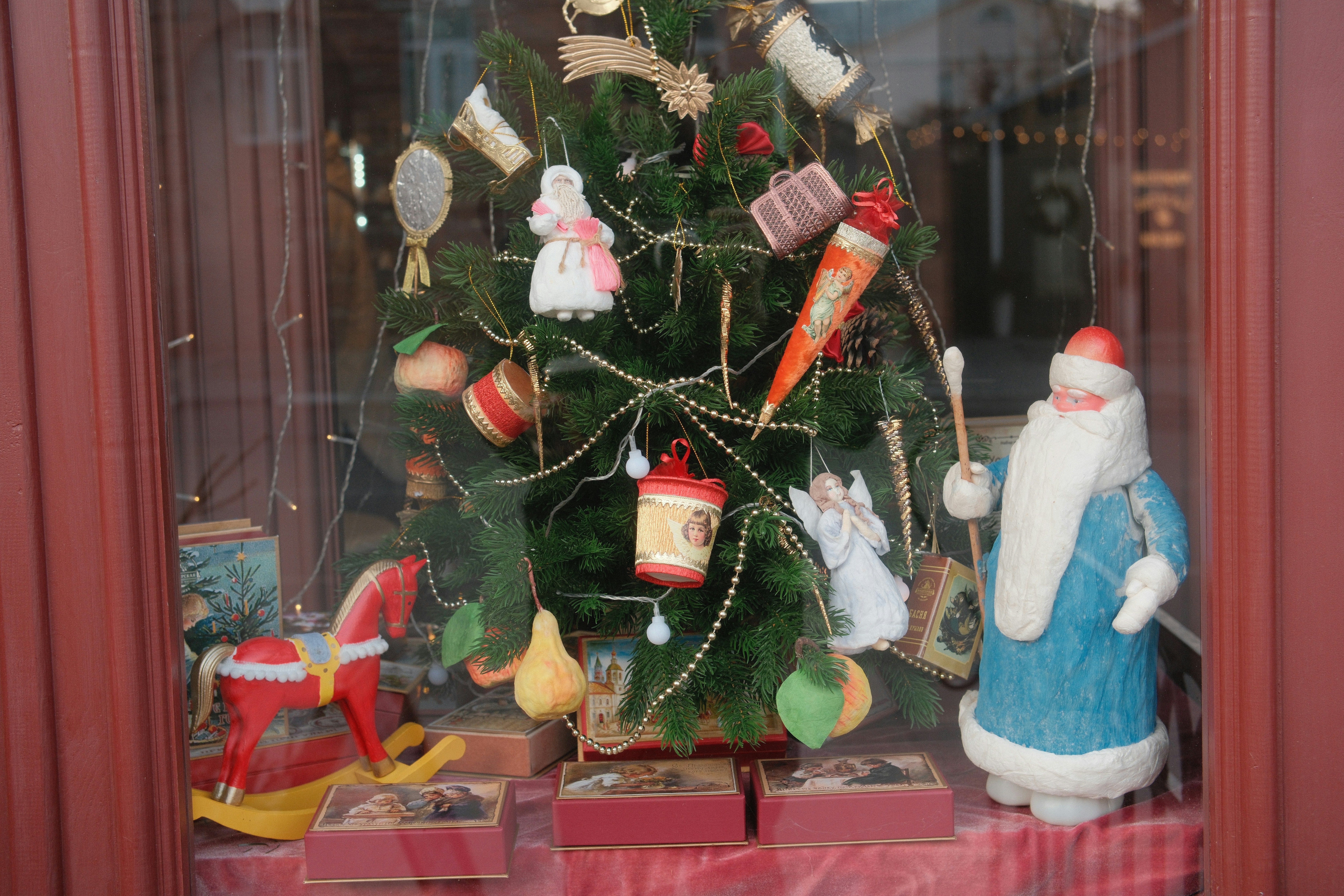 Candy-Boxed Christmas: A Festive Window Scene with a Plush Santa