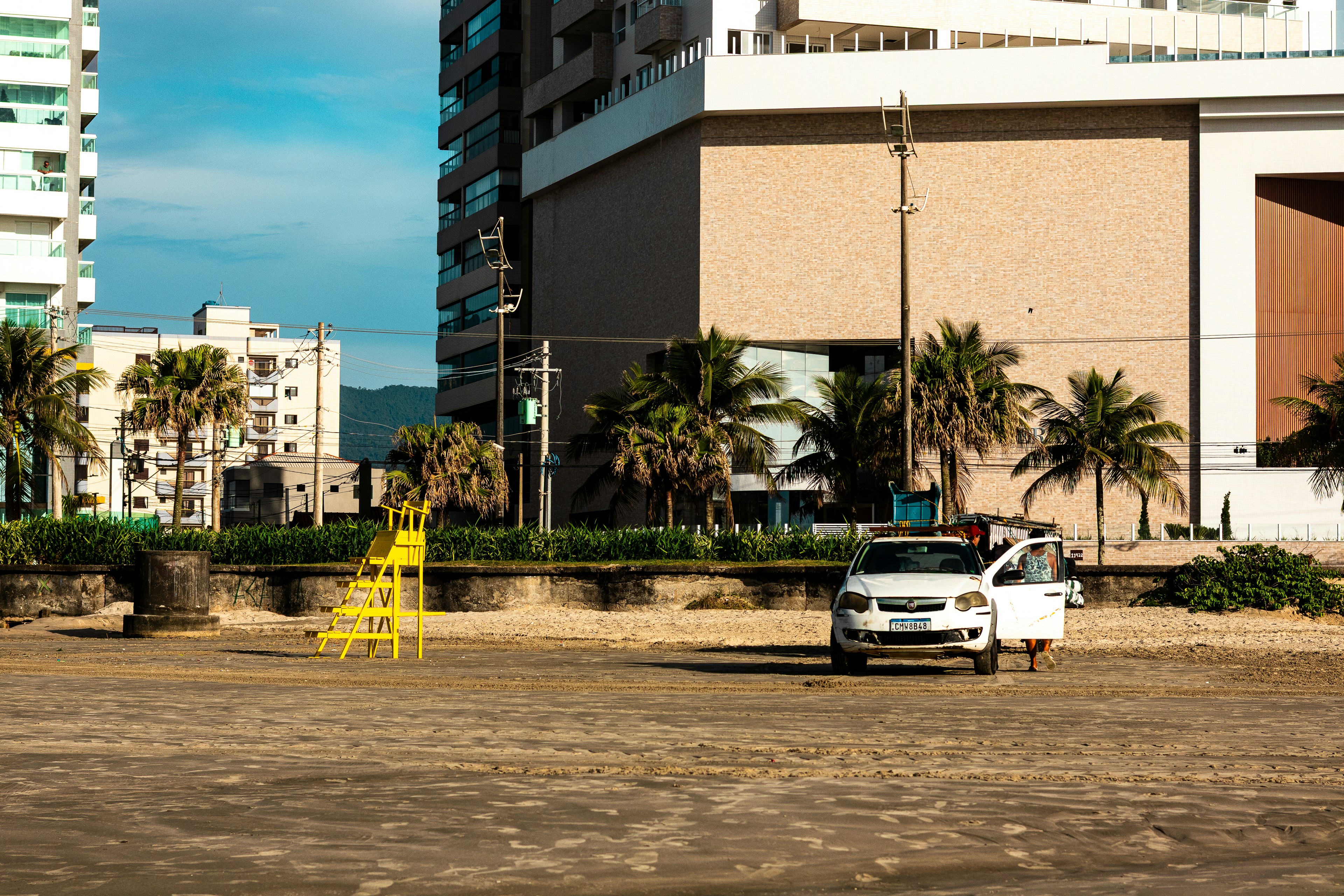 Coastal Cityway: A Security Car at Dune-Textured Beachfront