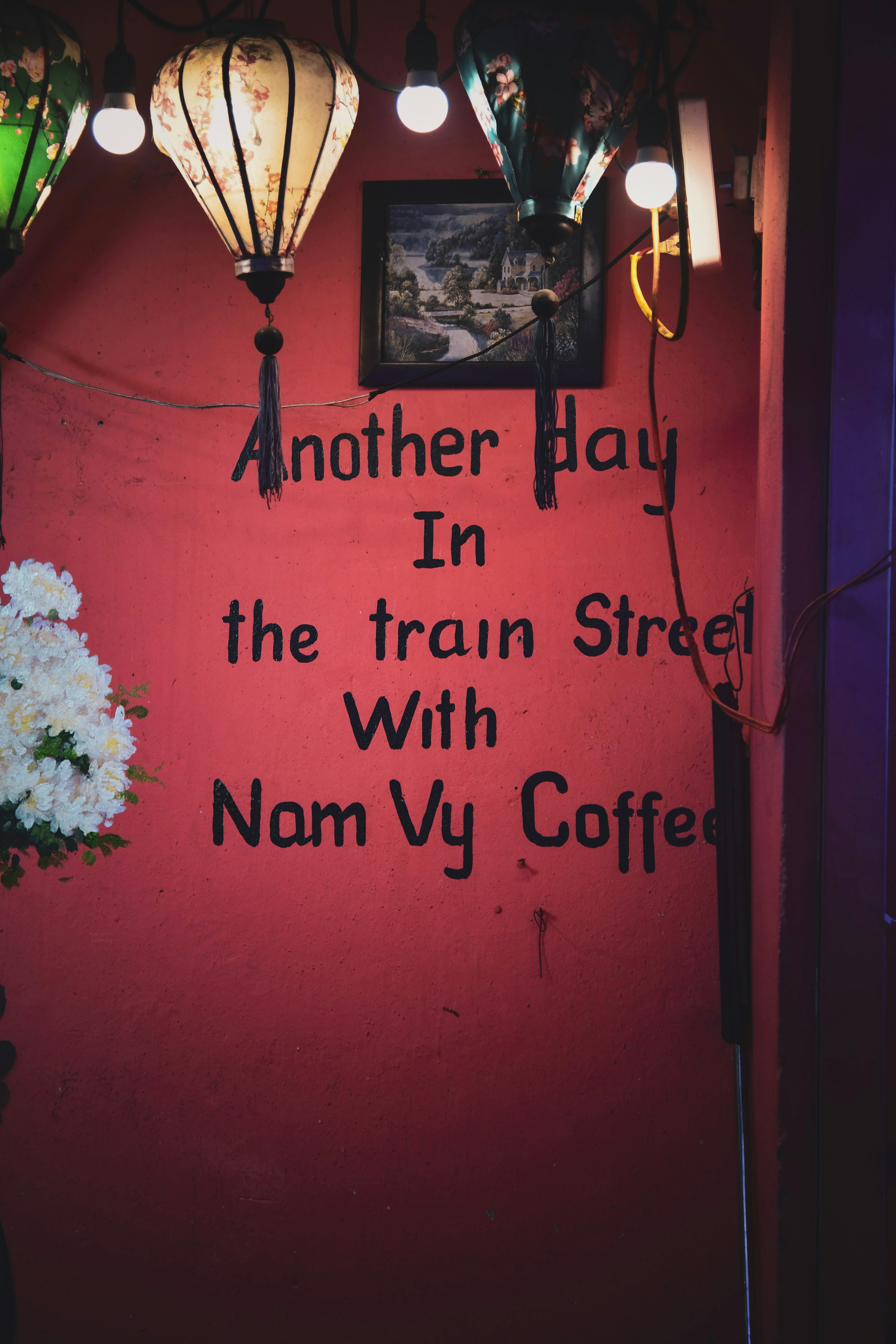 Lanterns and Latte: A Cozy Red Wall Cafe Scene