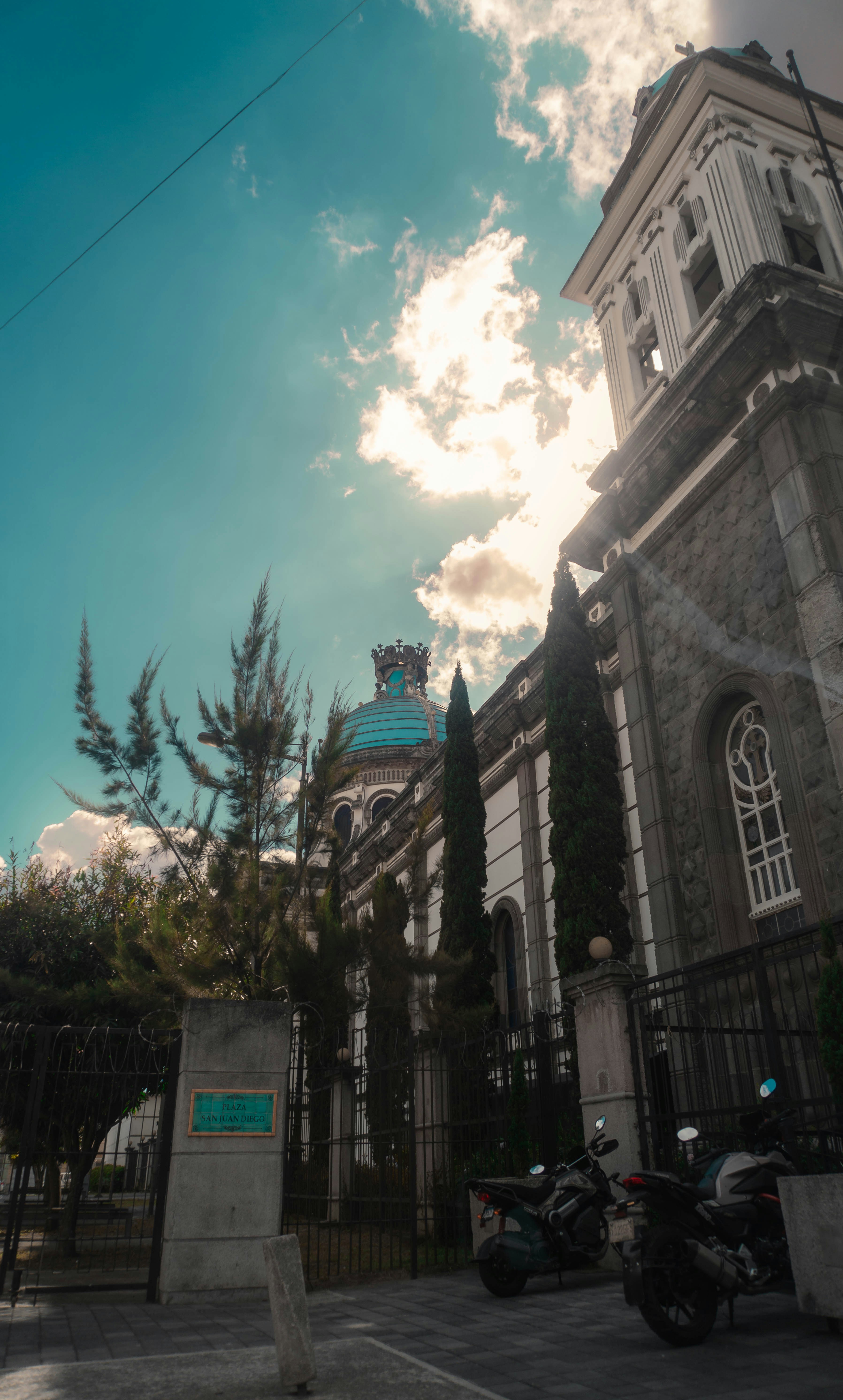 Cathedral Corner: Sunlit Turrets and Blue Dome Revealing a Quiet Street