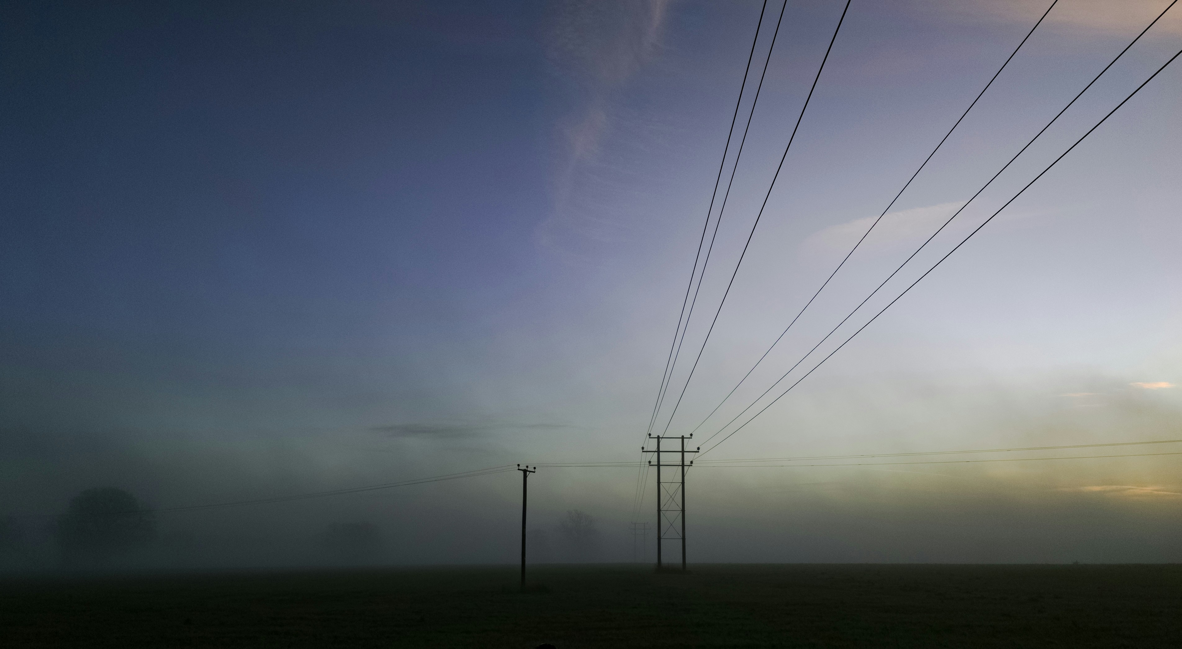 Low Sun, High Lines: A Quiet Field Under Distant Power