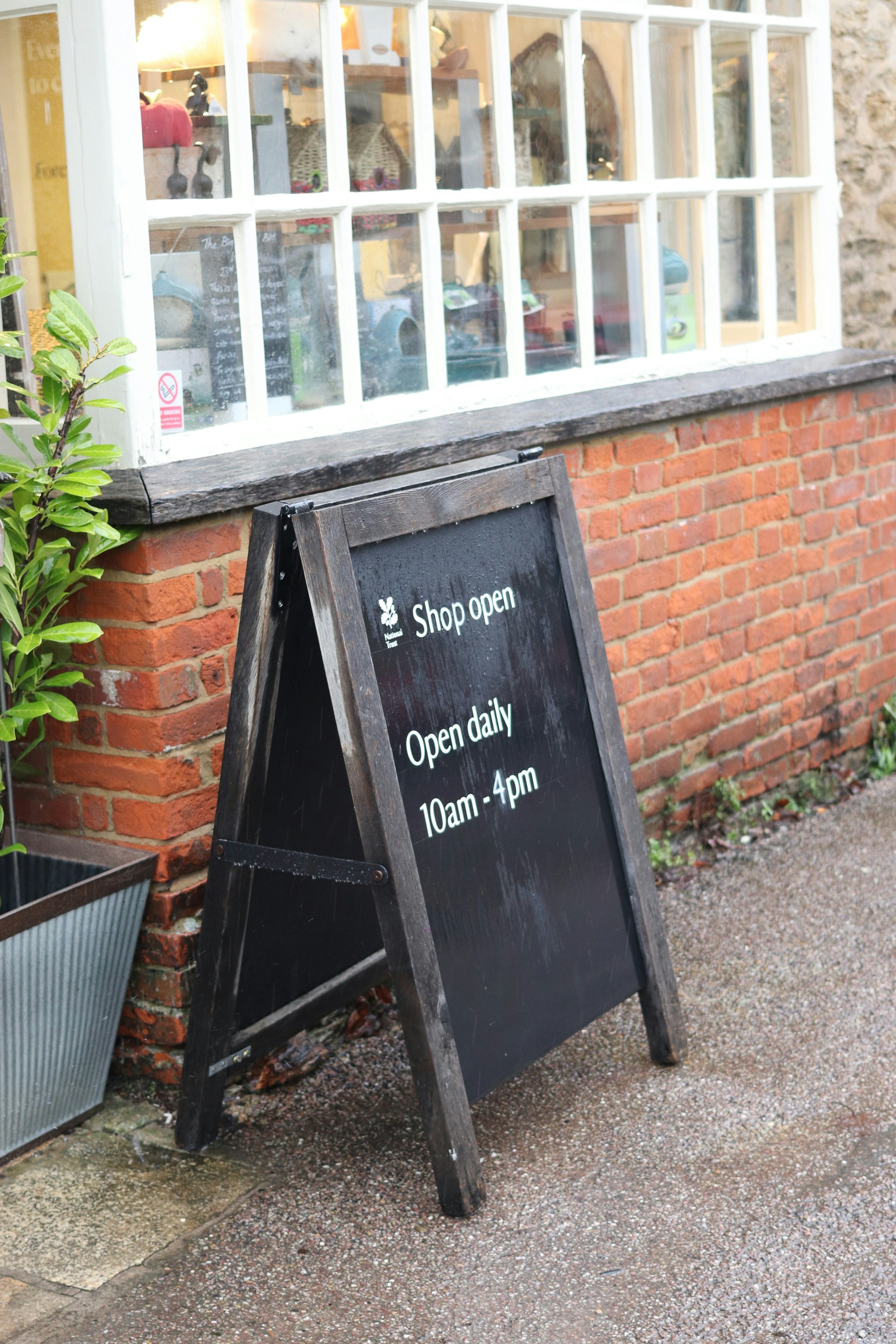 A-frame sign outside a shop showing opening hours. photo – Free ...