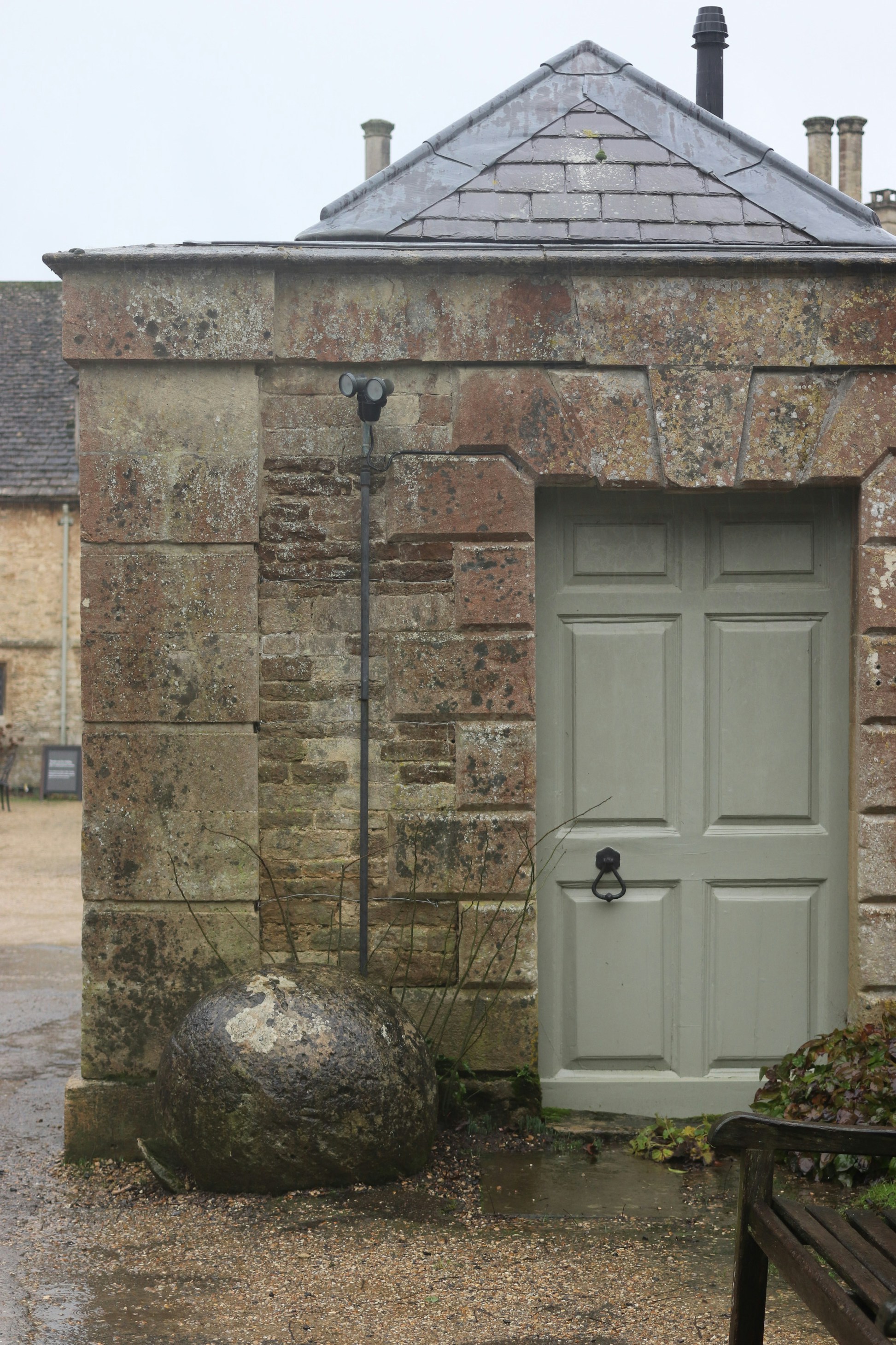 Stone-Walled Doorway Under a Mansard Roof