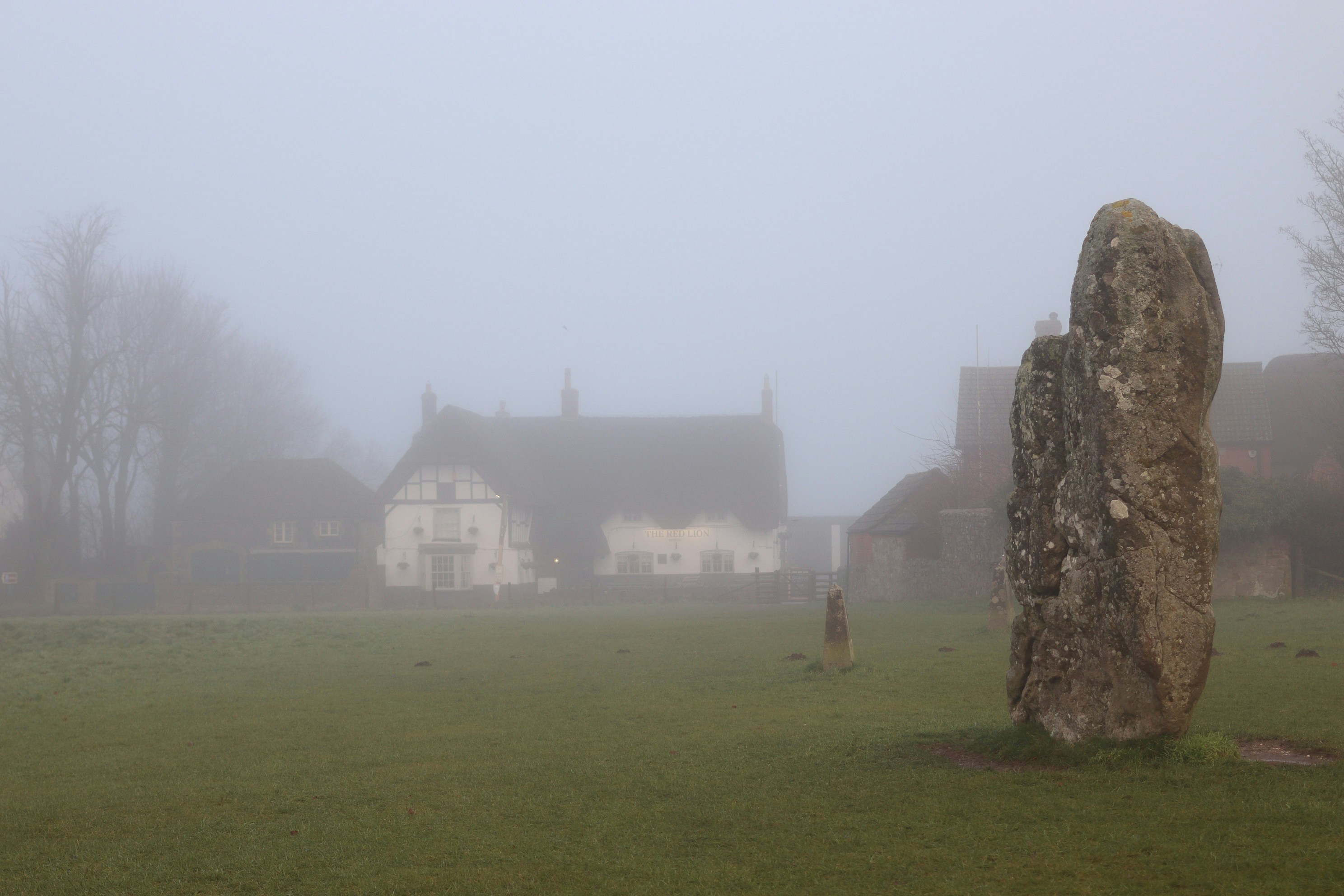 Stone Sentinel in the Mist: A Village Hidden by Fog