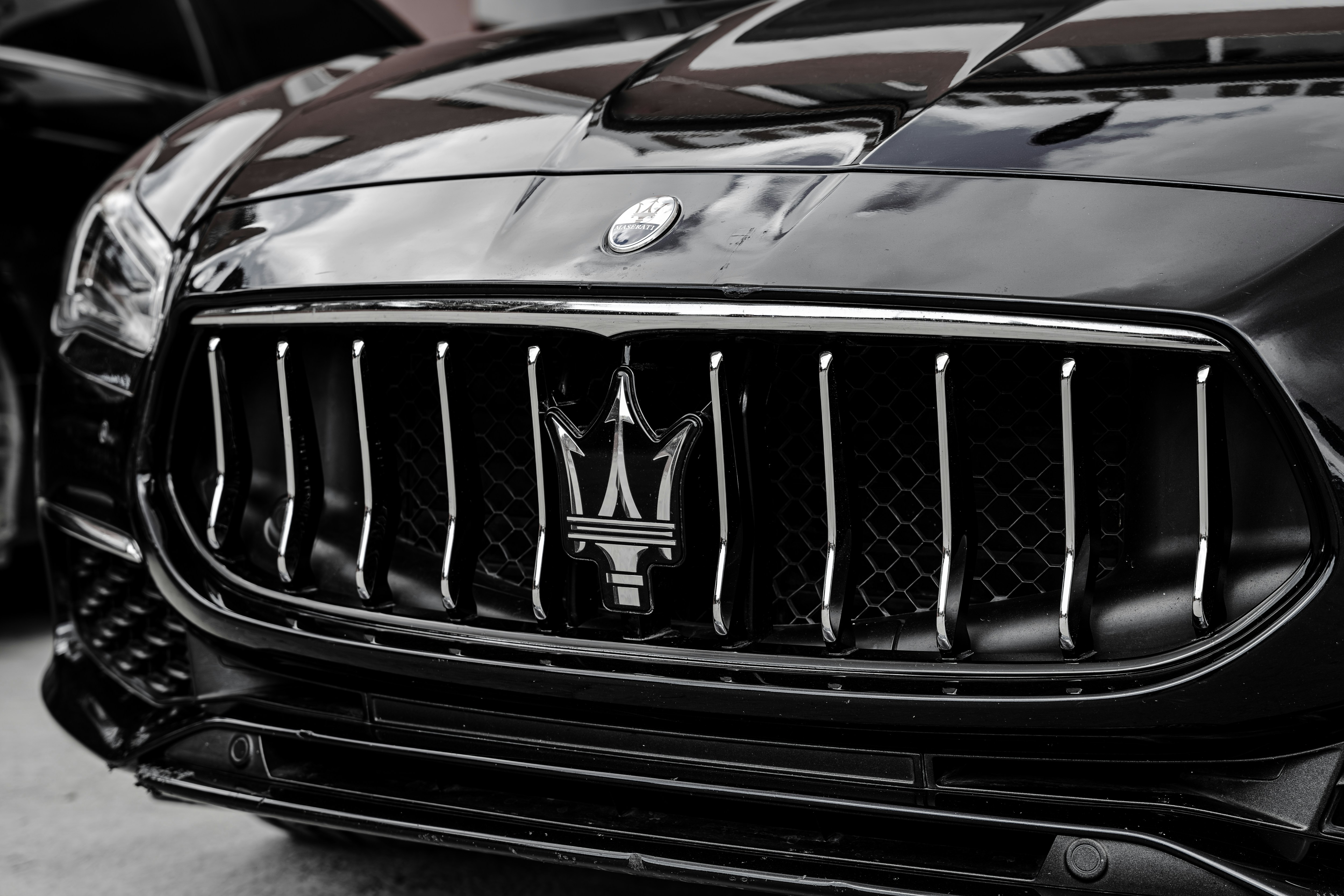 Majestic Maserati Grille: Chrome Stripes and Emblem in Focus